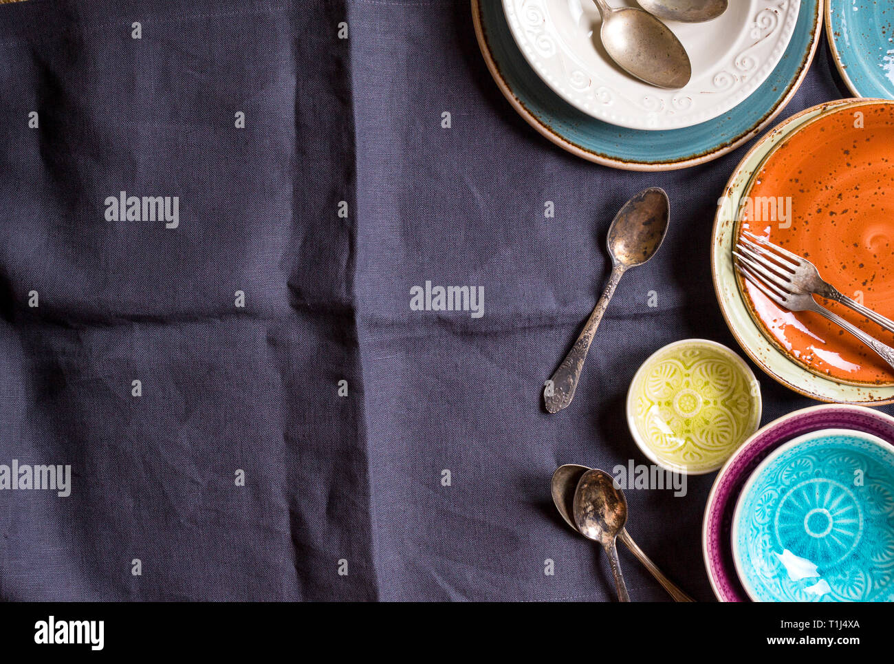 Different empty plates background Stock Photo - Alamy