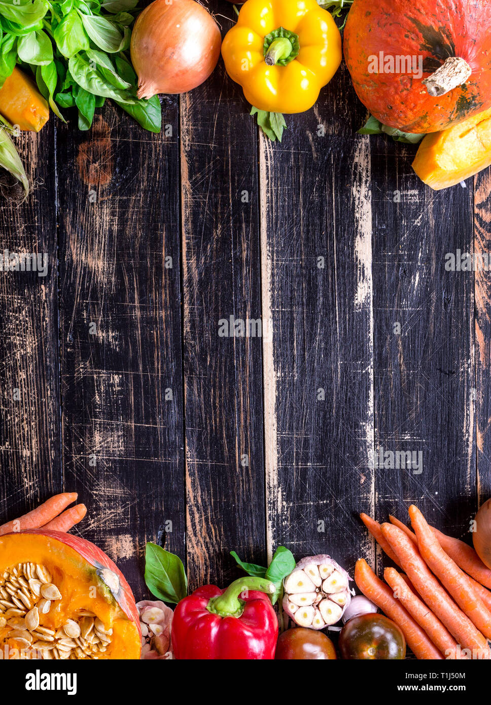 Fresh vegetables on a rustic dark textured table. Autumn background ...