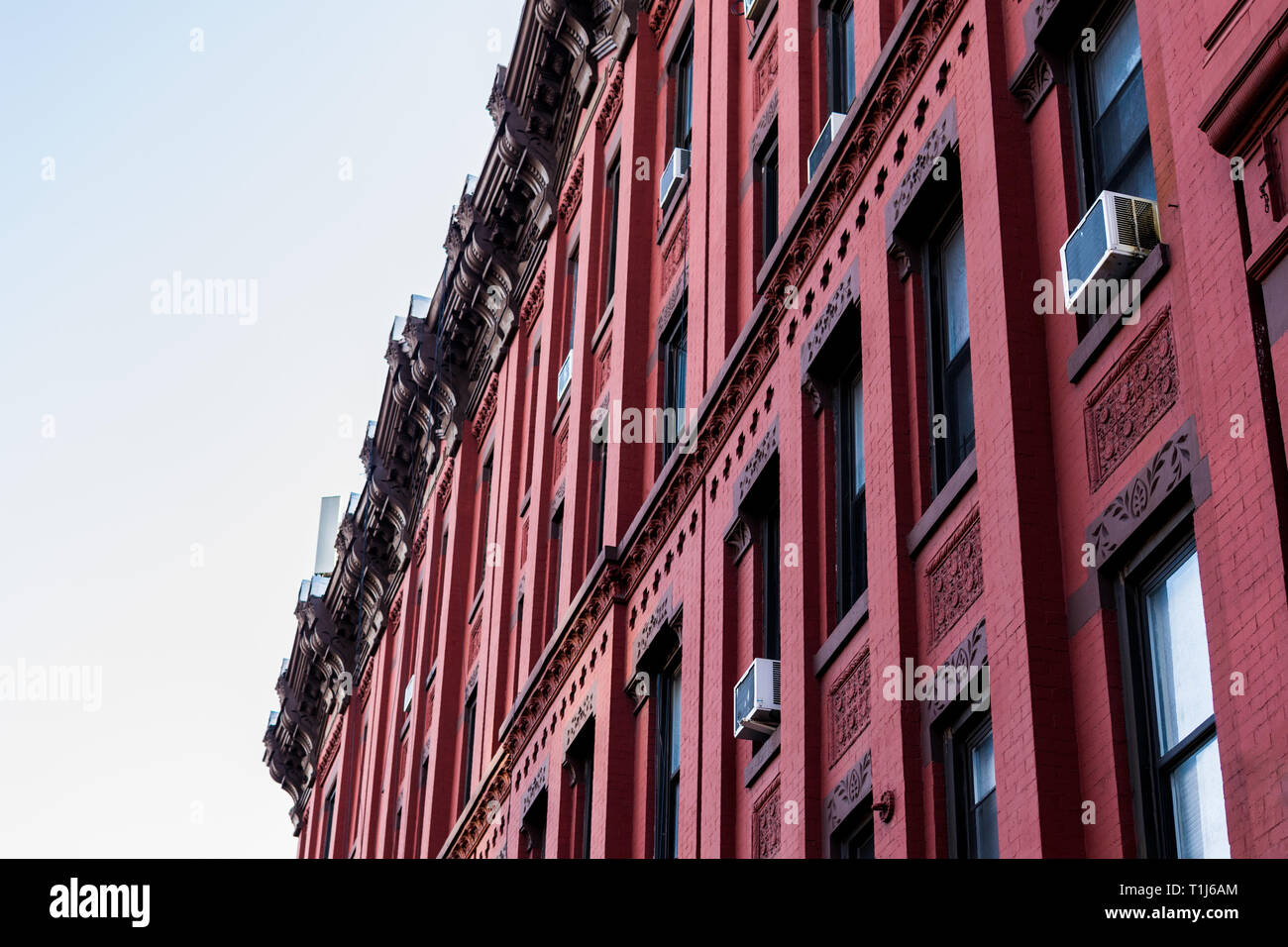 Red facade of a typical Harlem brownstone building, Manhattan, New York ...