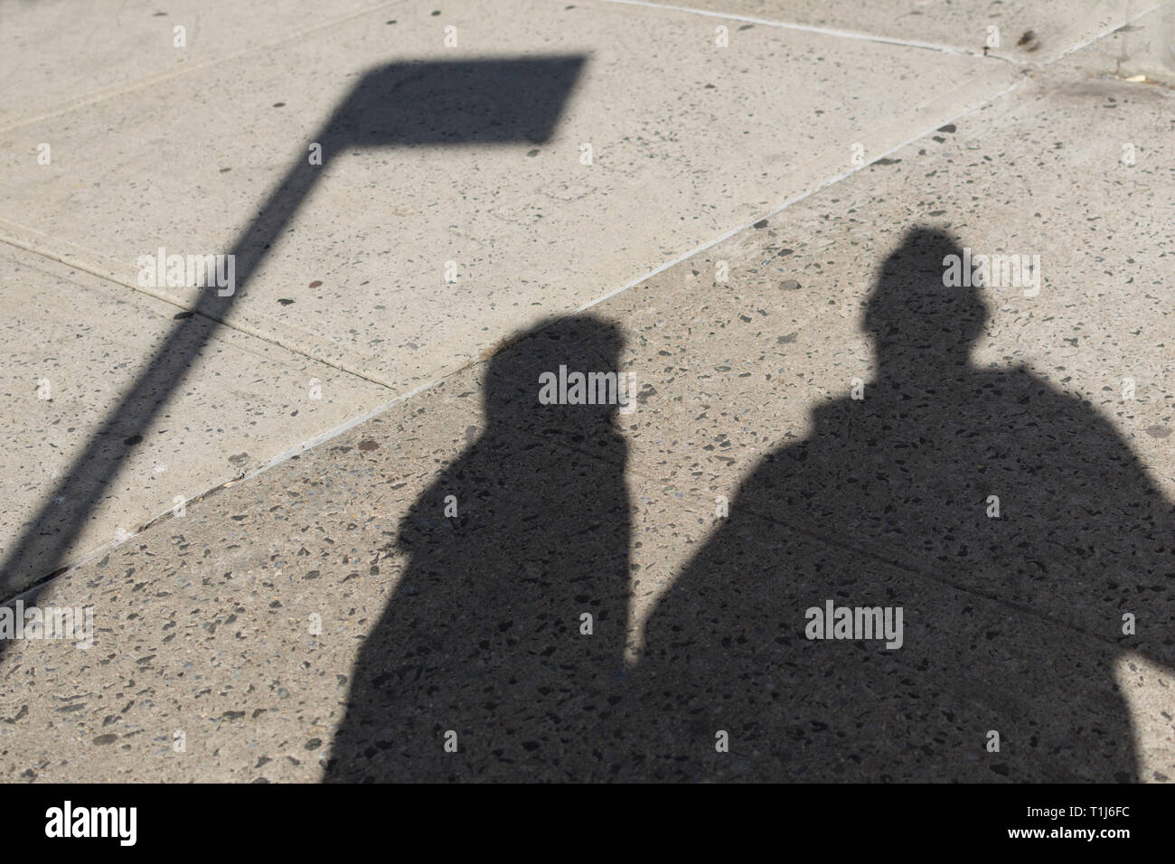 Shadows of a father and son on a rough concrete street Stock Photo - Alamy