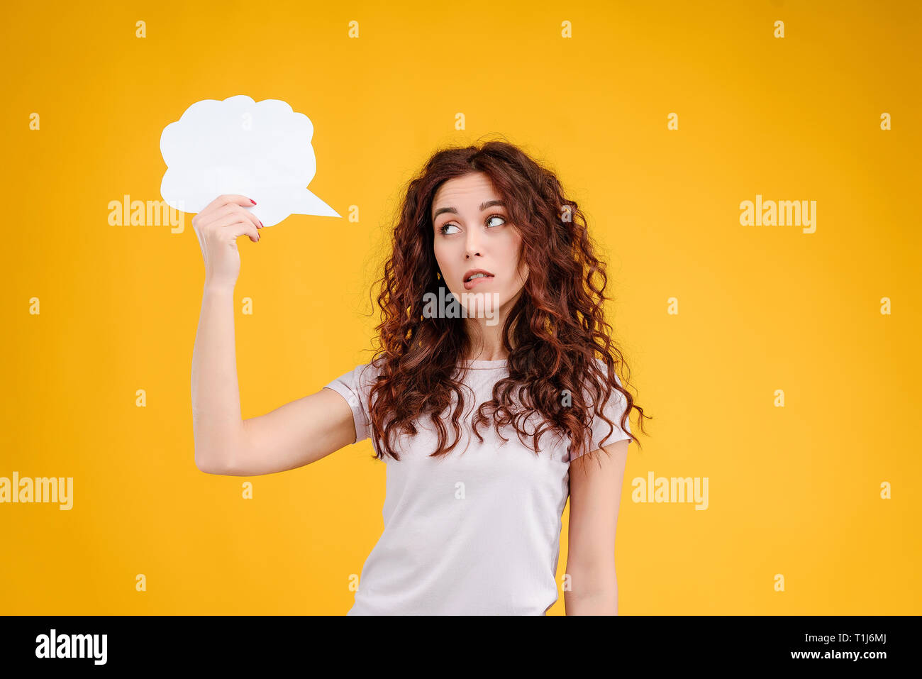 Attractive Brunette Girl With Curly Hair Isolated Over Yellow