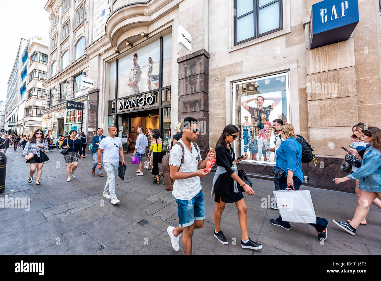 London, UK - June 24, 2018: Many people crowd walking on sidewalk ...