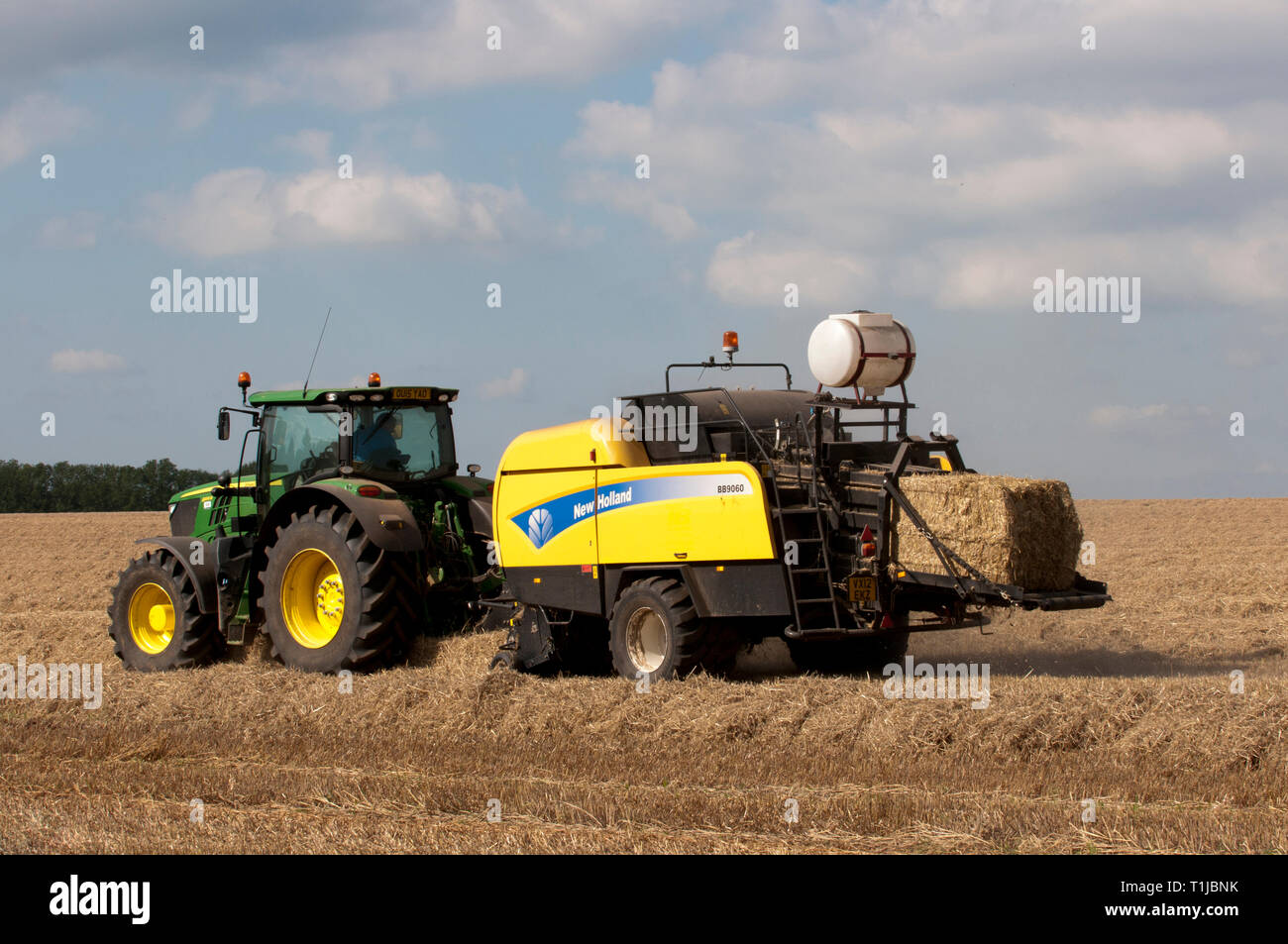 Dry straw being gathered and made into straw bales Stock Photo - Alamy