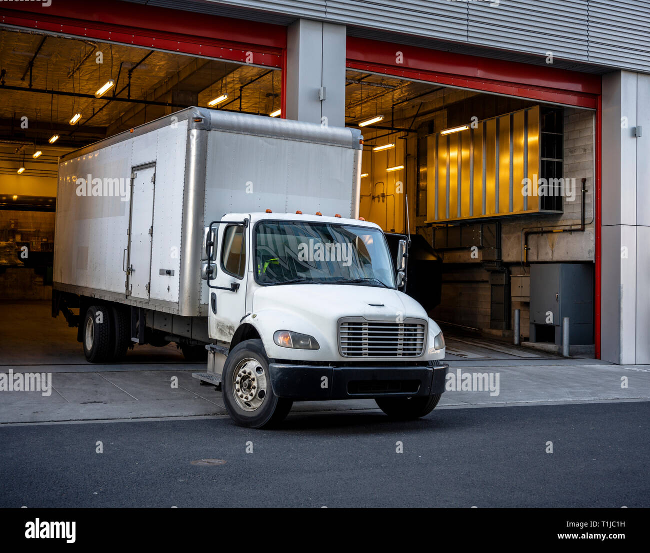 The middle-duty white day cab compact semi truck for local shipping and ...