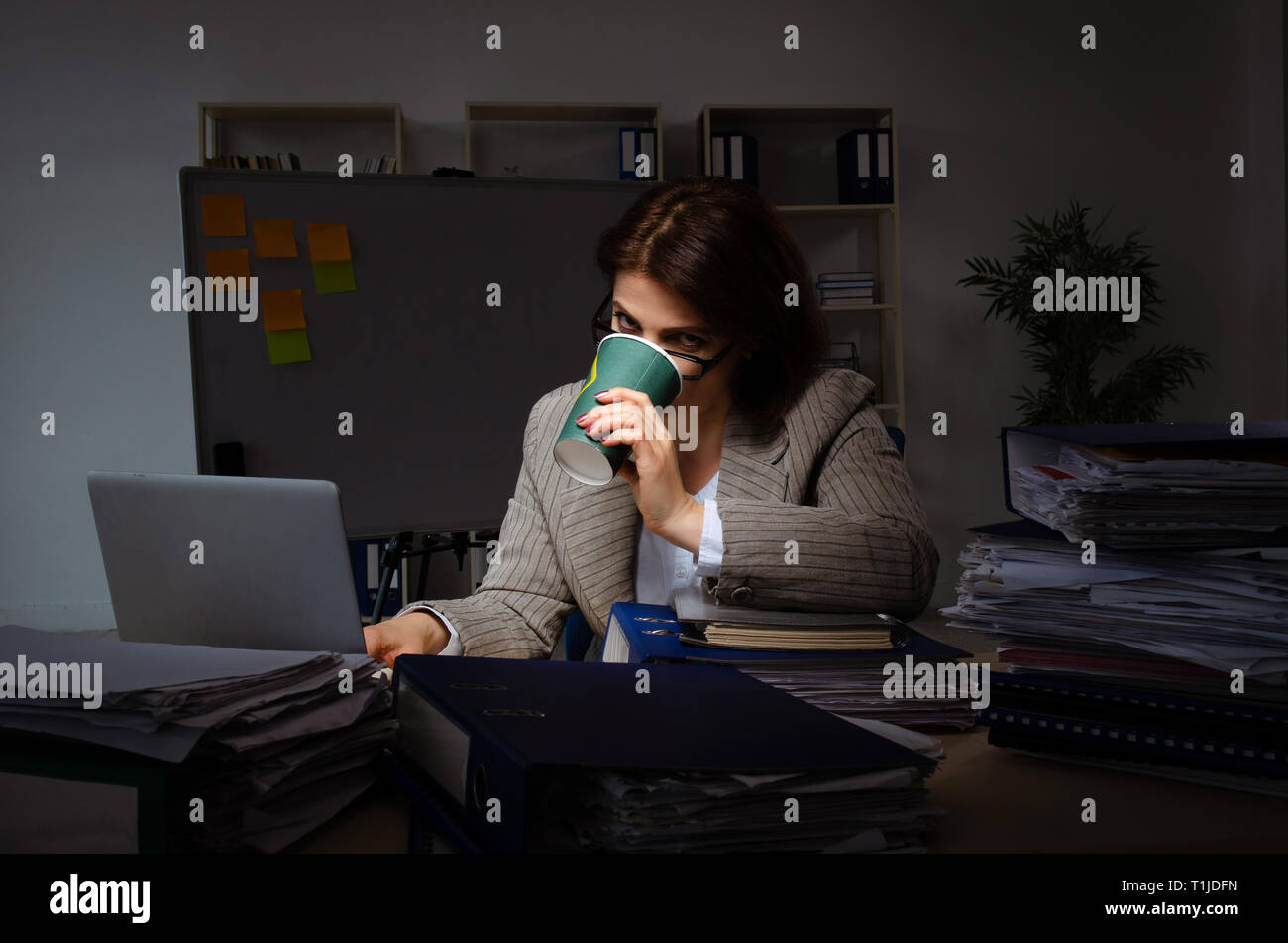 Female employee suffering from excessive work Stock Photo - Alamy