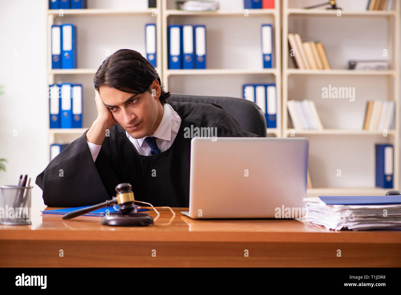 Young handsome judge working in court Stock Photo - Alamy