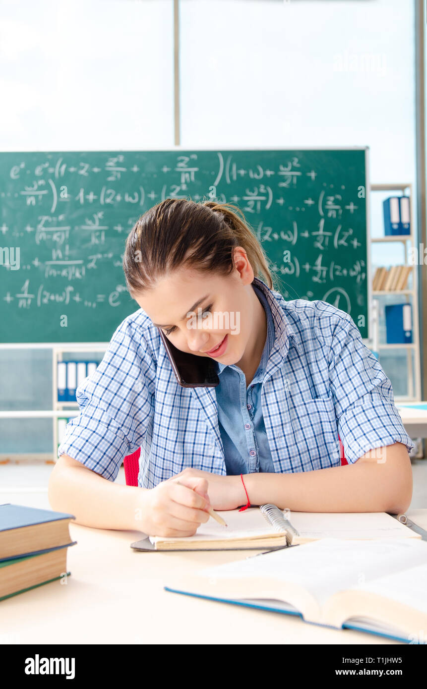 Young female student taking the exam in classroom Stock Photo - Alamy