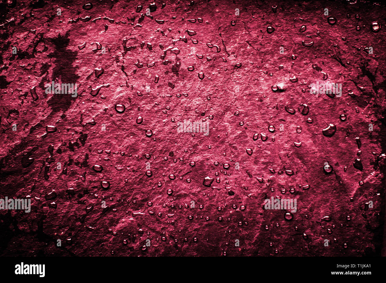Liquid drops on old stone wall as an abstract background ...