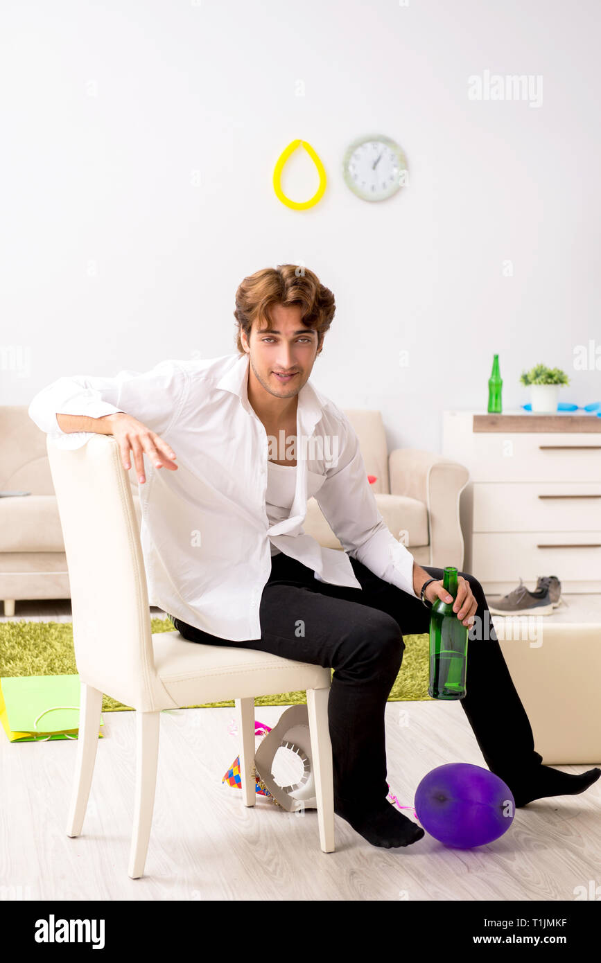 Young man having hangover after party Stock Photo - Alamy