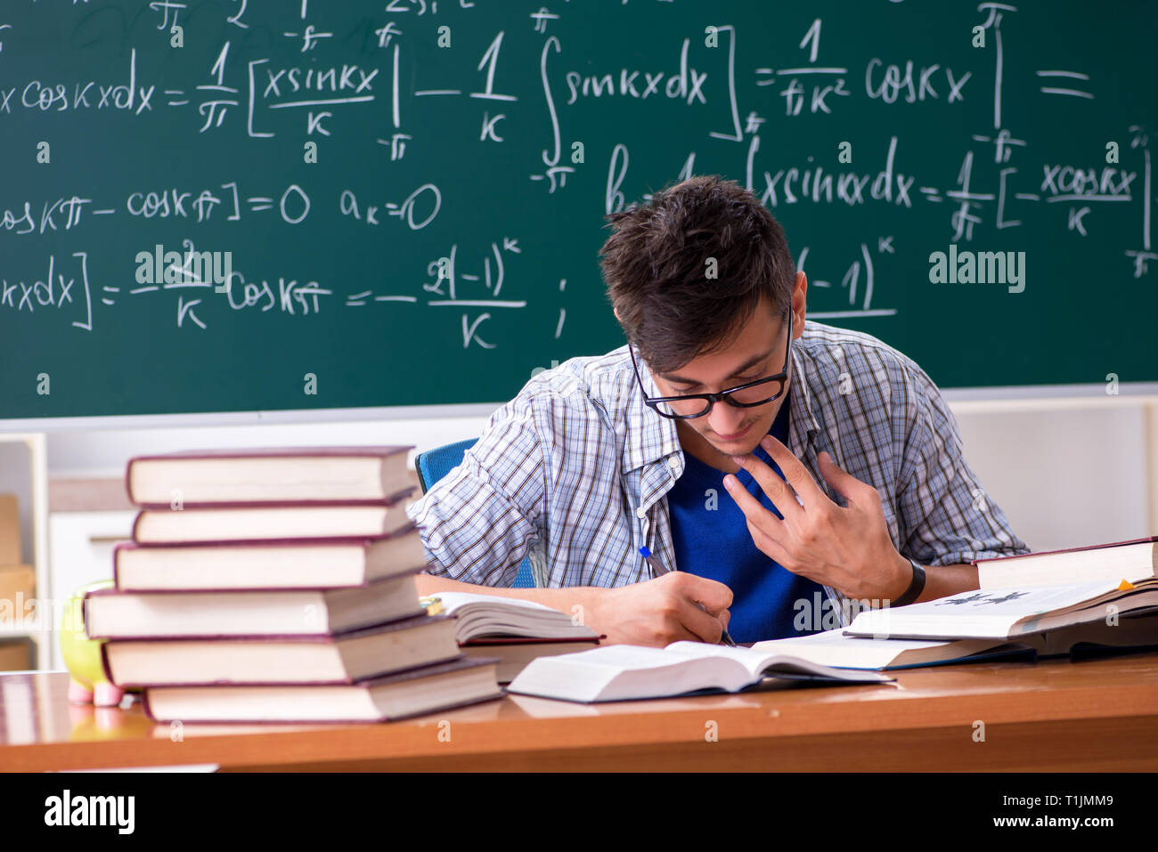 Young male student studying math at school Stock Photo - Alamy