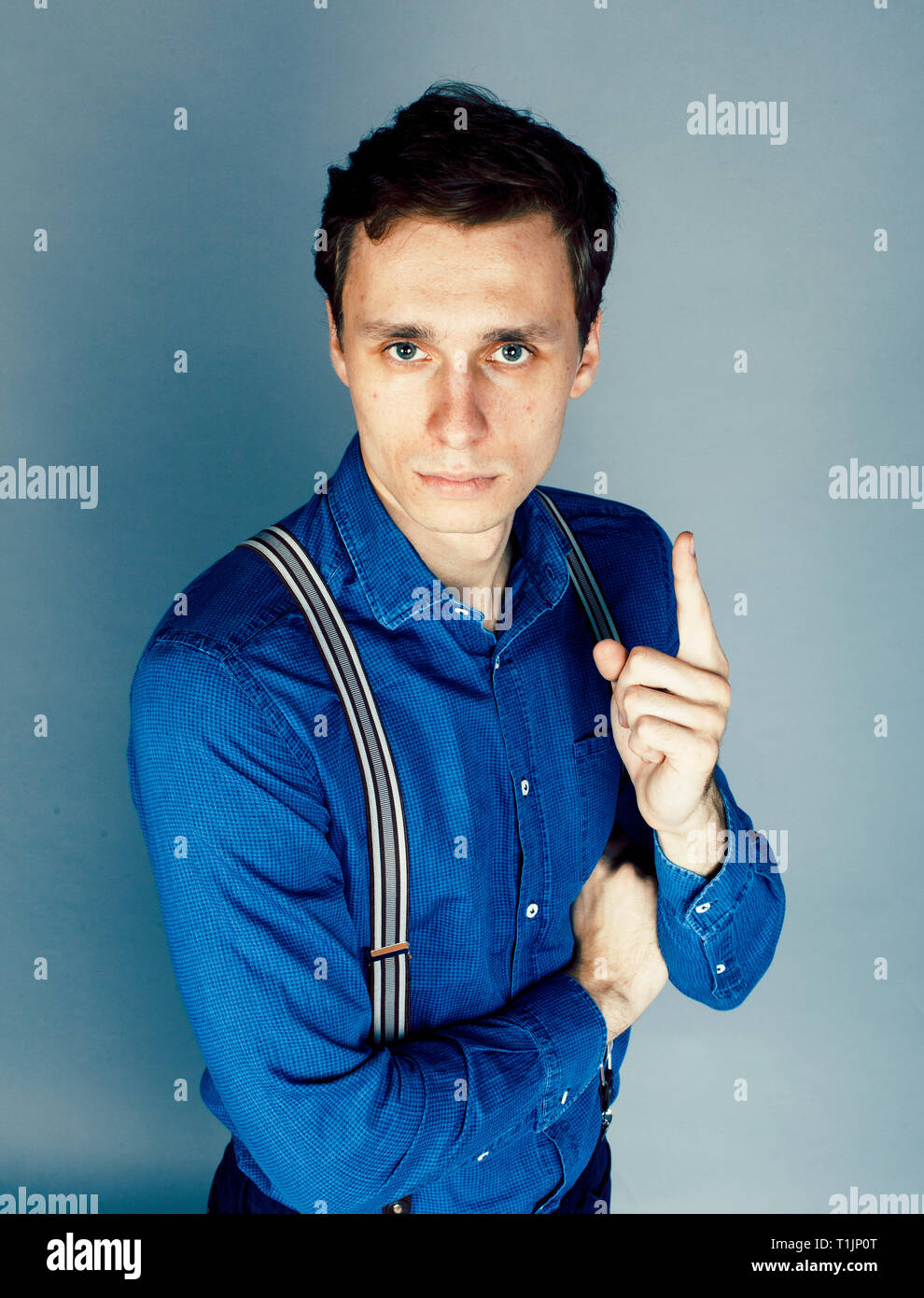 young goofy man with pimples pointing in studio Stock Photo - Alamy