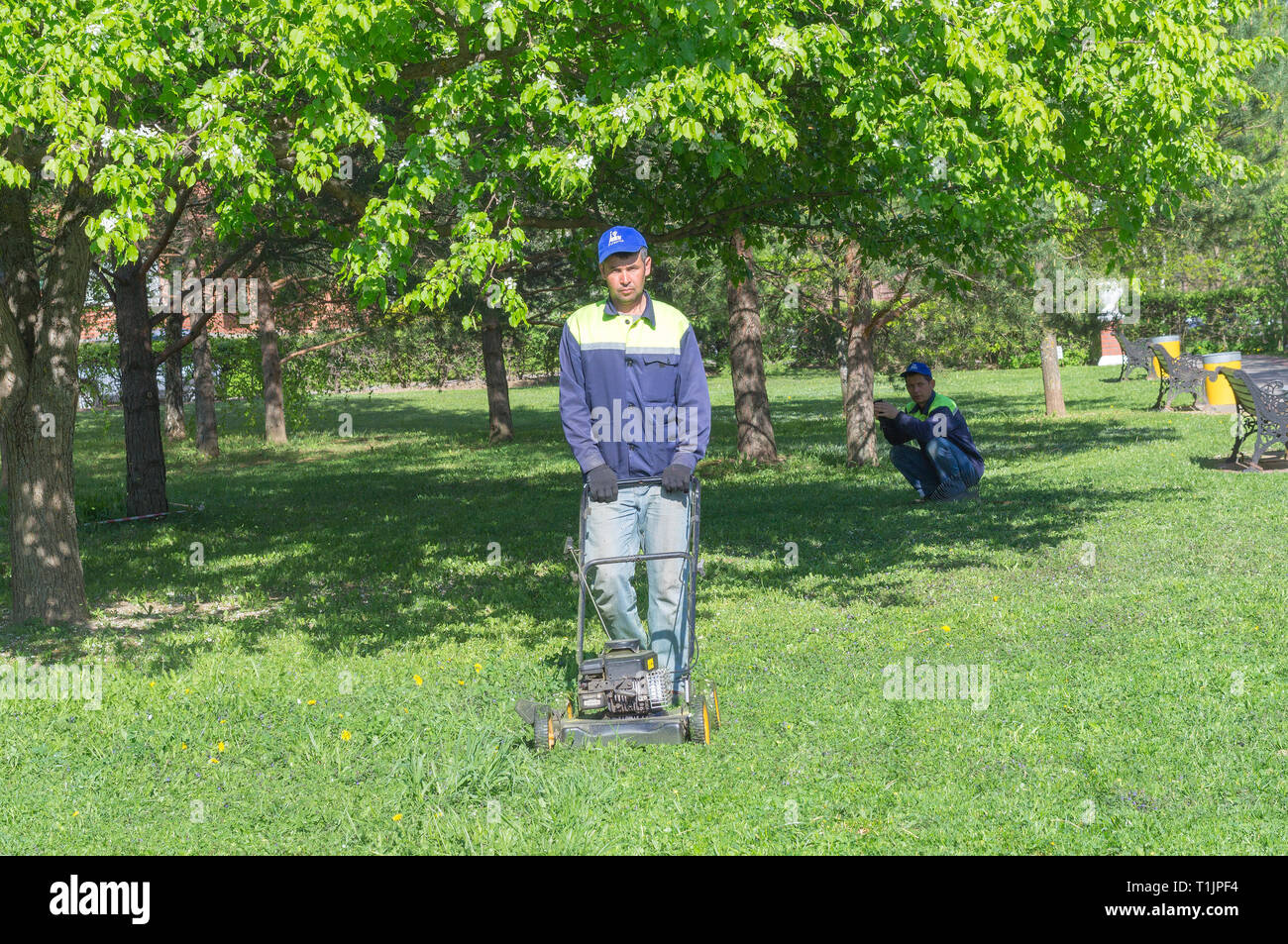 Moscow, Russia - May 12, 2018: Man Cutting Grass With Lawn Mower ...