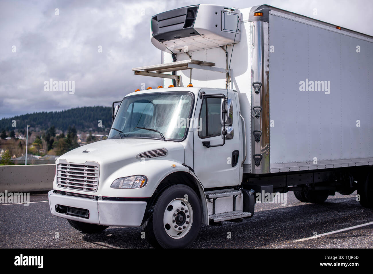 The middle-duty white day cab compact semi truck for local shipping and ...