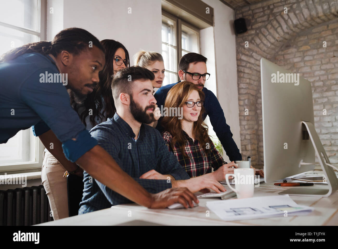 Picture of architects working together in office Stock Photo - Alamy