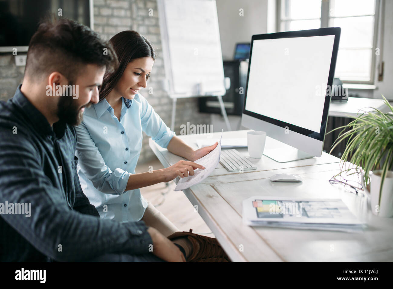 Young architects working on project in office Stock Photo - Alamy