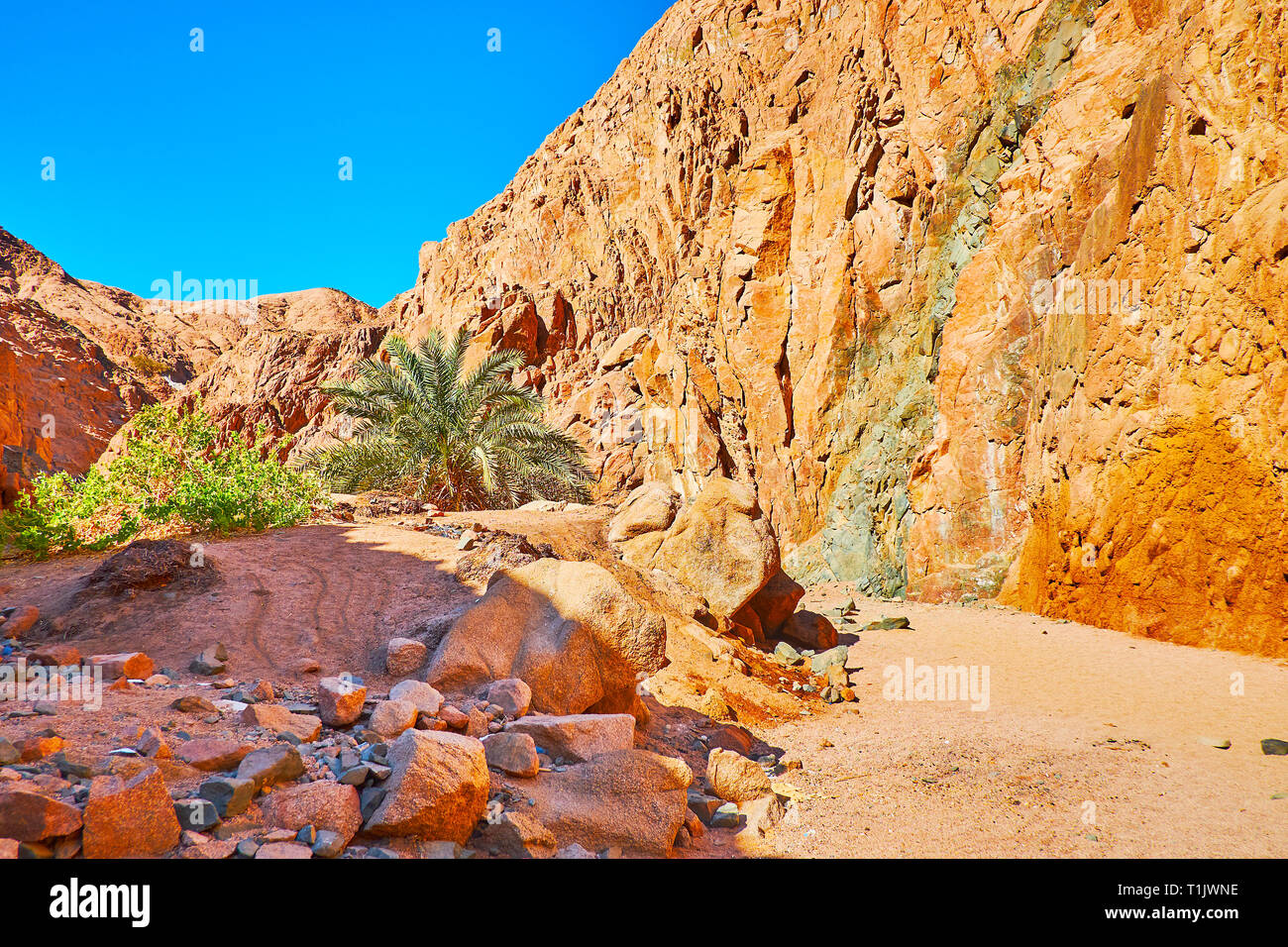The scenic landscape of Small Colored canyon with steep red rocks and ...