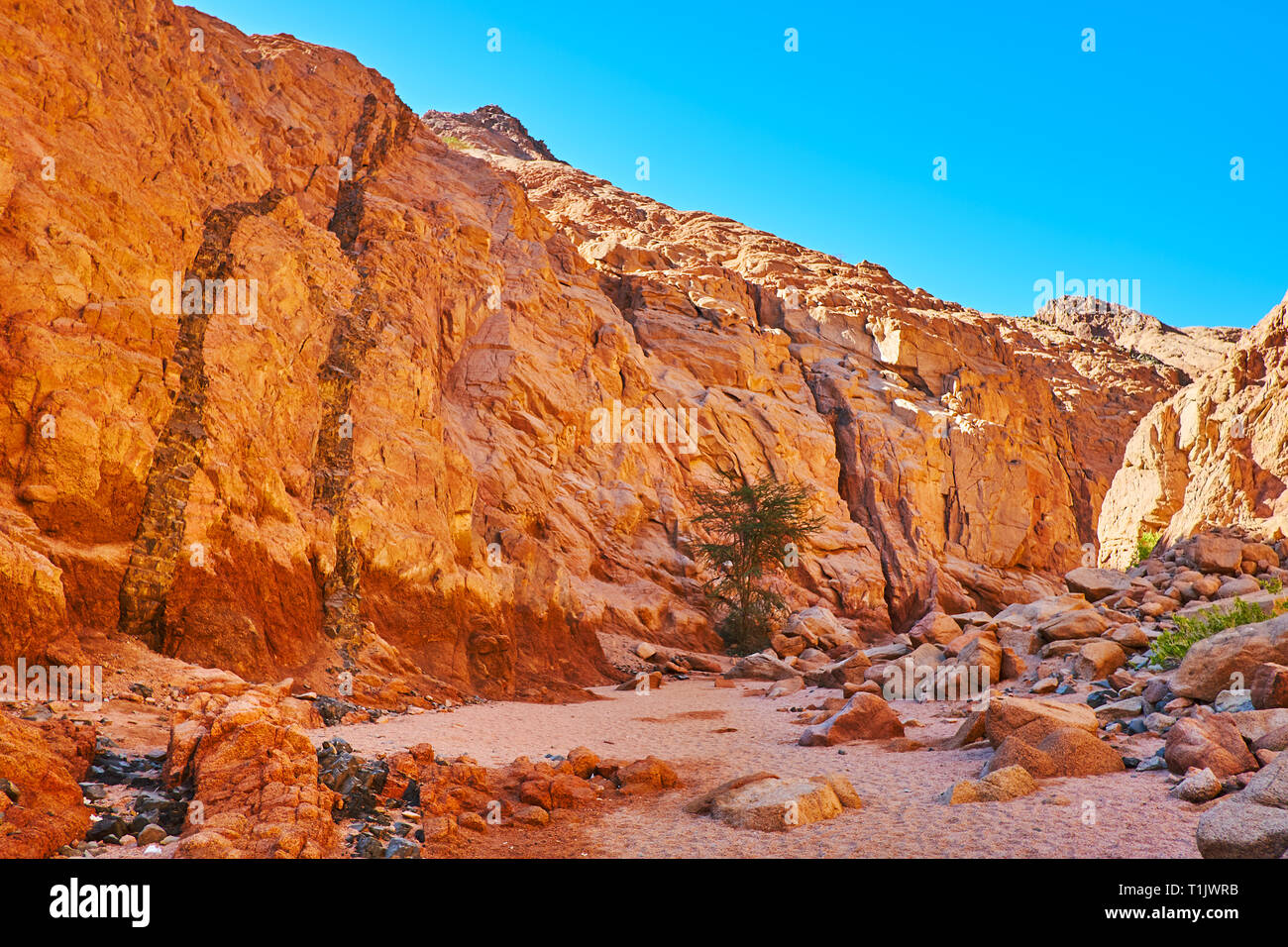 Observe the red rocks of Small Colored canyon with multicolored ...