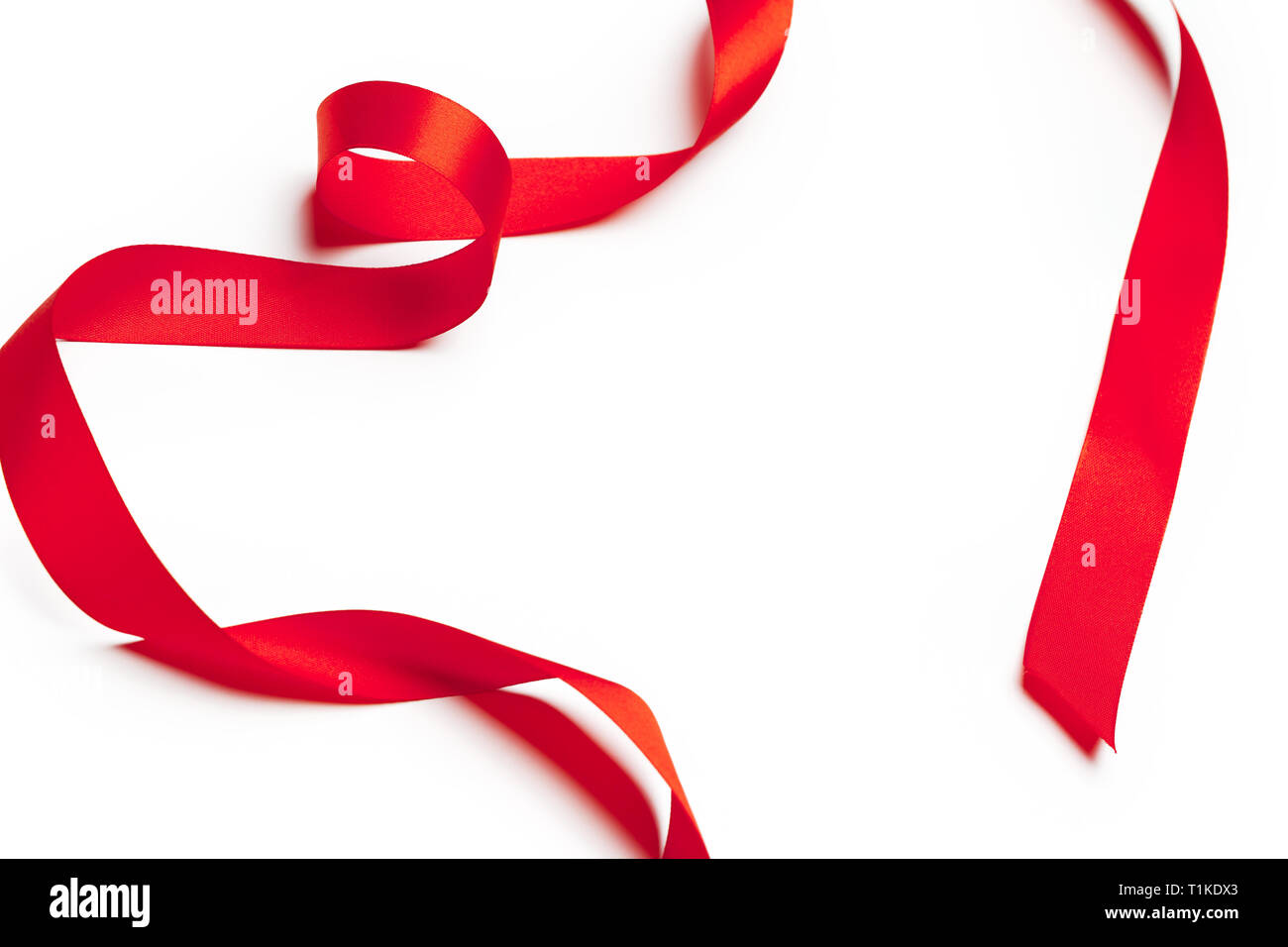 Red ribbon on white background Stock Photo - Alamy