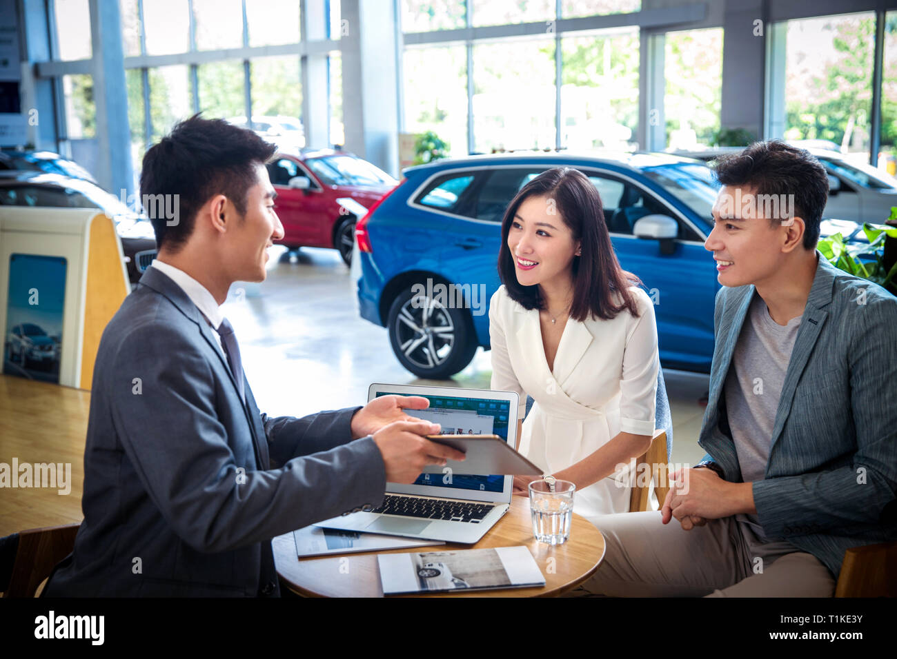 Car sales staff and customers Stock Photo - Alamy