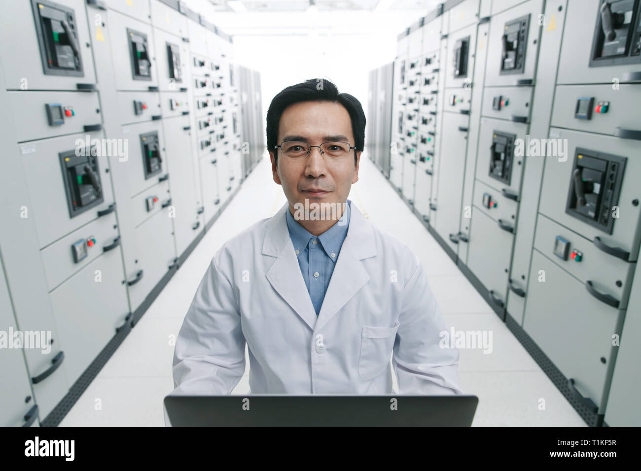 Mid adult man using technical equipment hi-res stock photography and ...