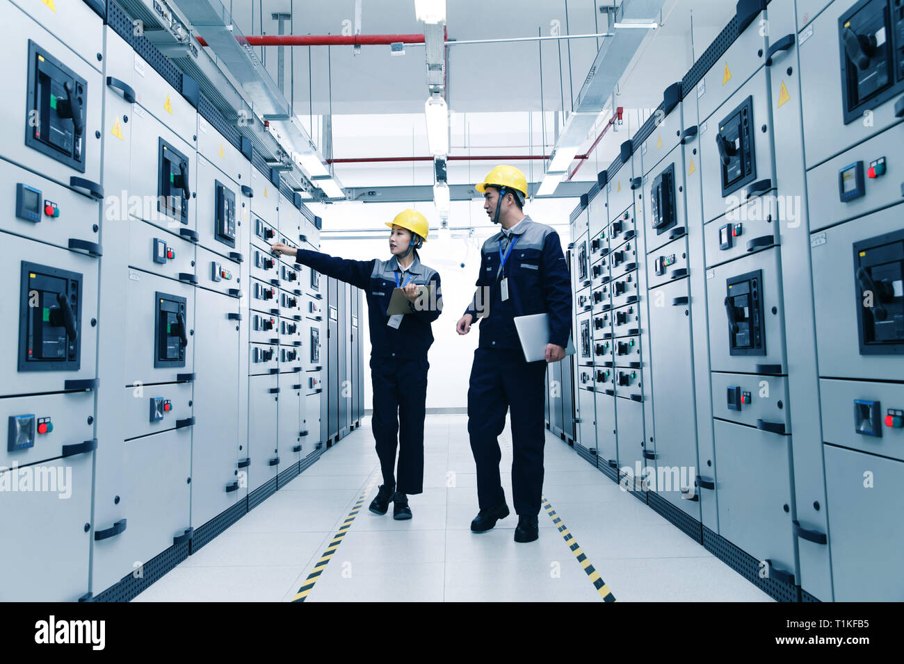 Technicians work in a factory Stock Photo - Alamy