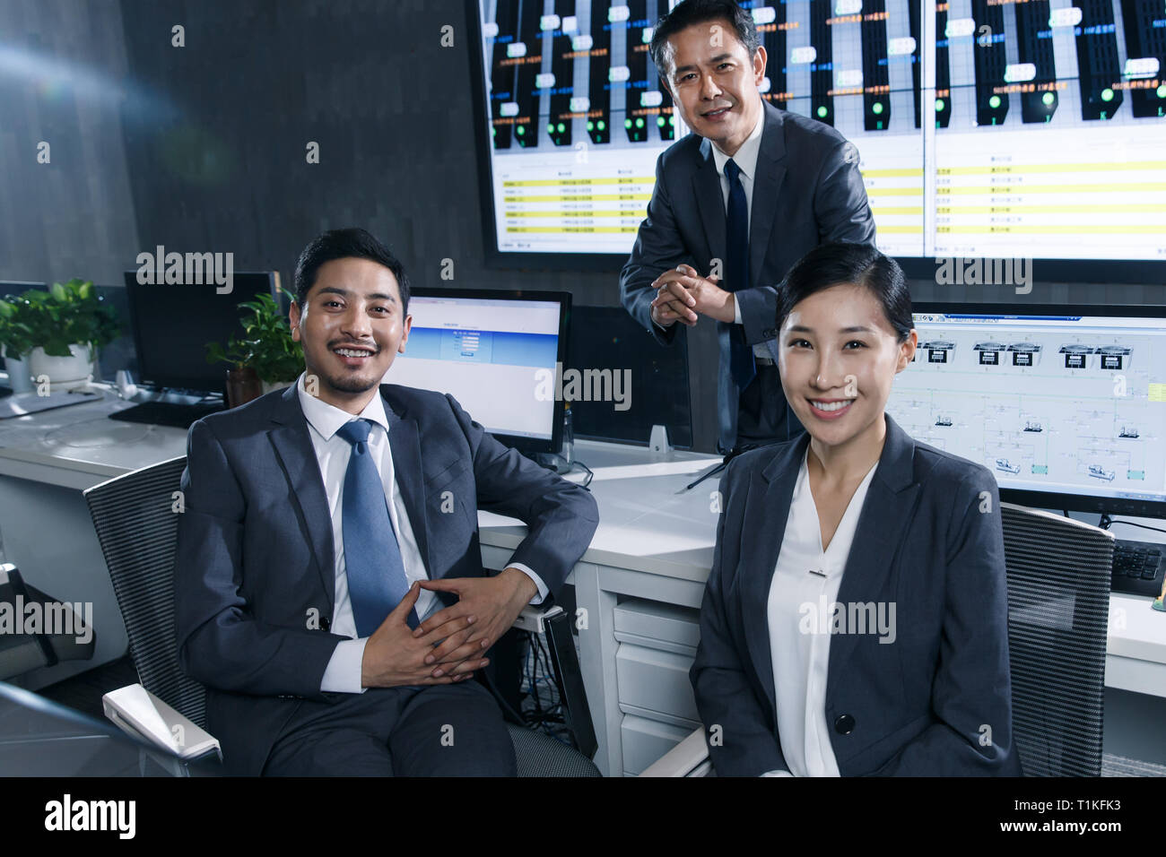 Business people in the control room Stock Photo - Alamy