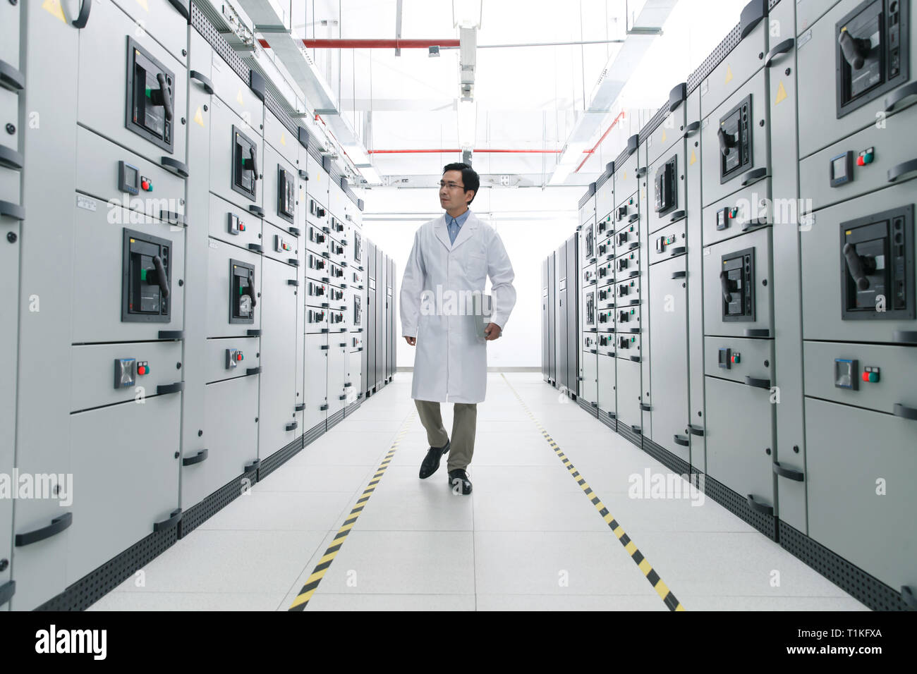 Technical personnel in the voltage room work Stock Photo - Alamy