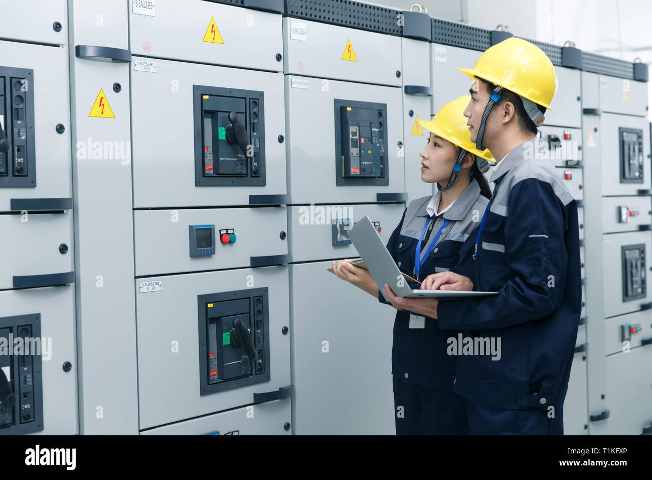 Technicians work in a factory Stock Photo - Alamy