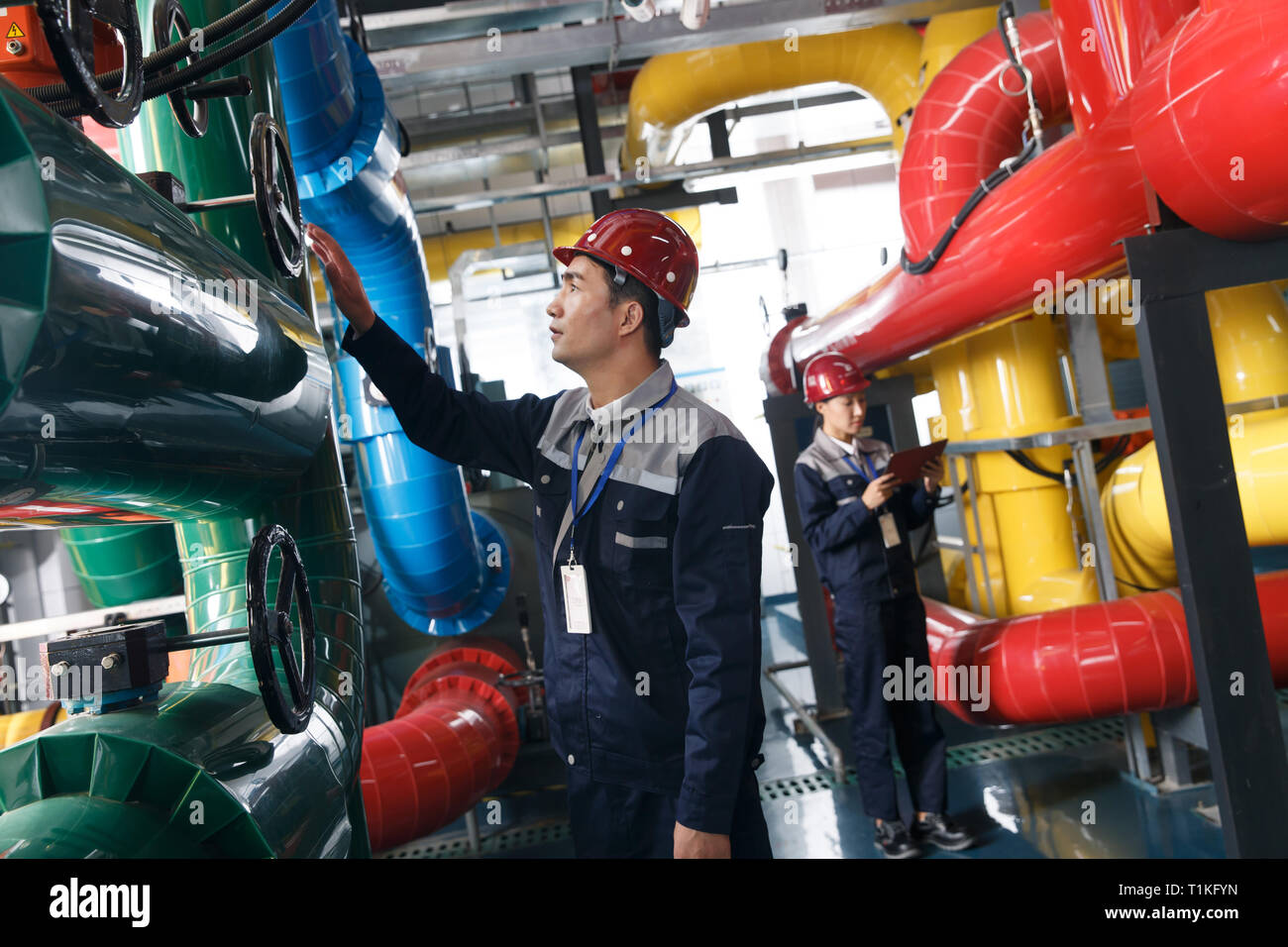 Technicians work in a factory Stock Photo - Alamy