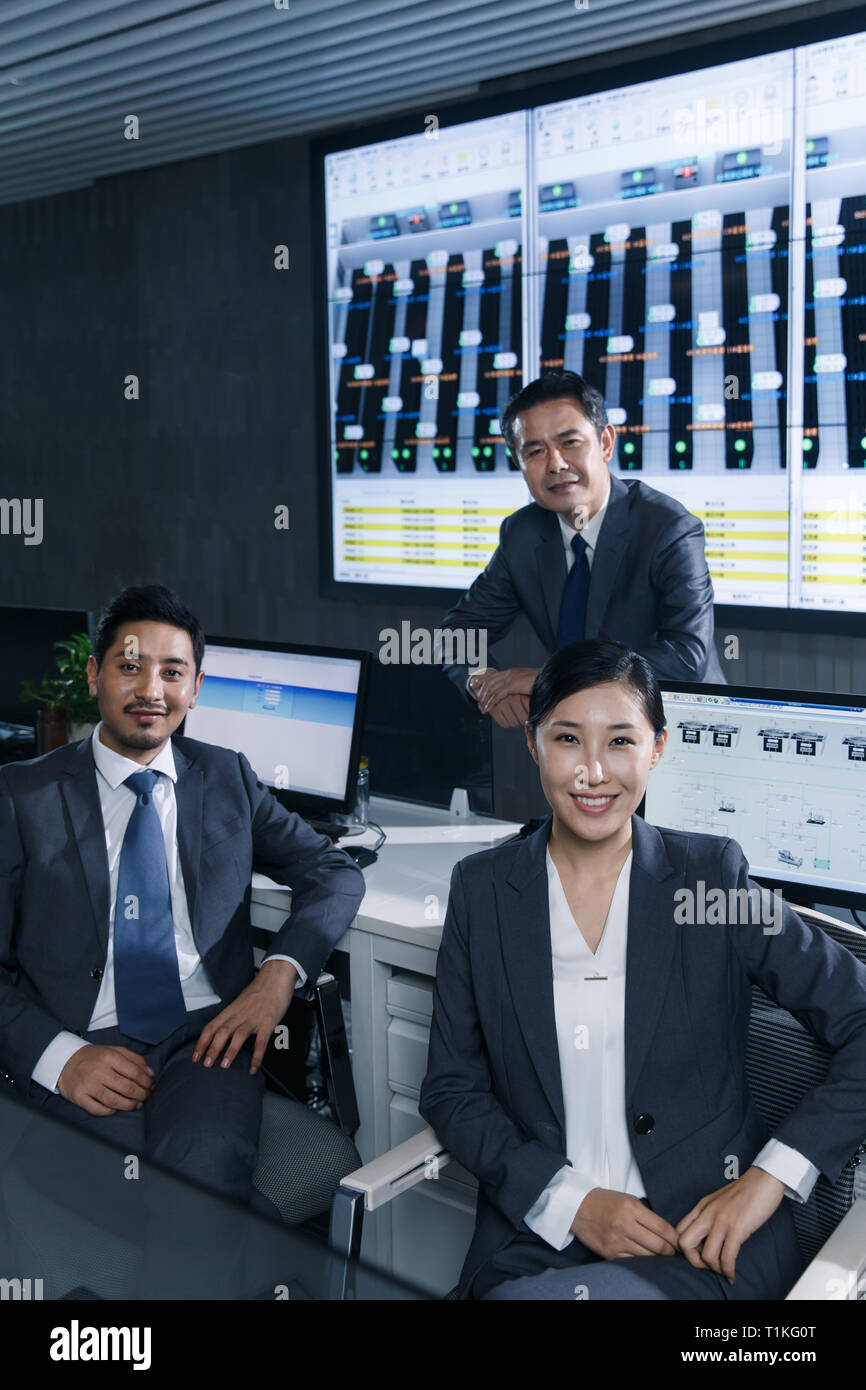 Business people in the control room Stock Photo - Alamy