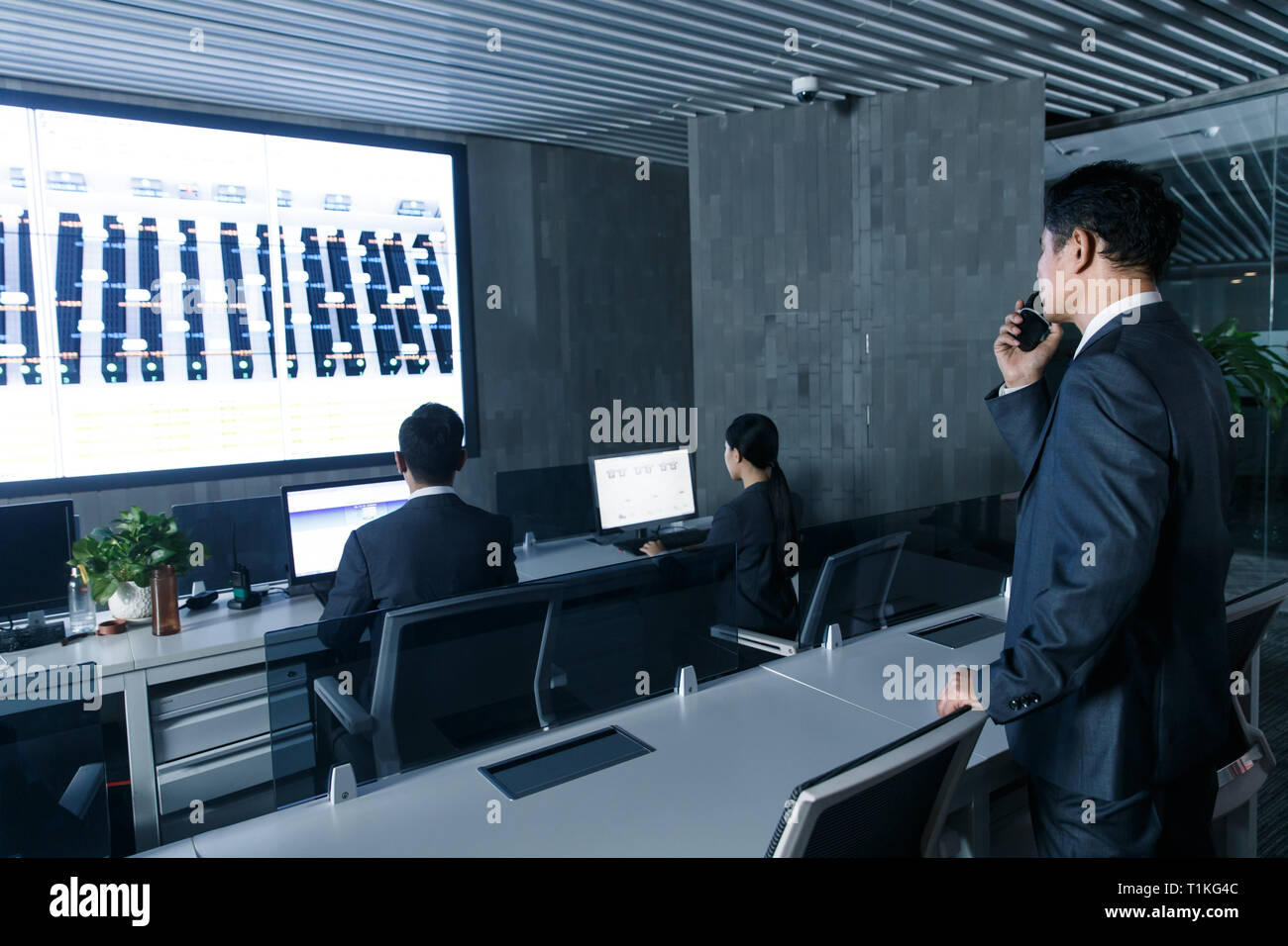 Business people in the control room Stock Photo - Alamy