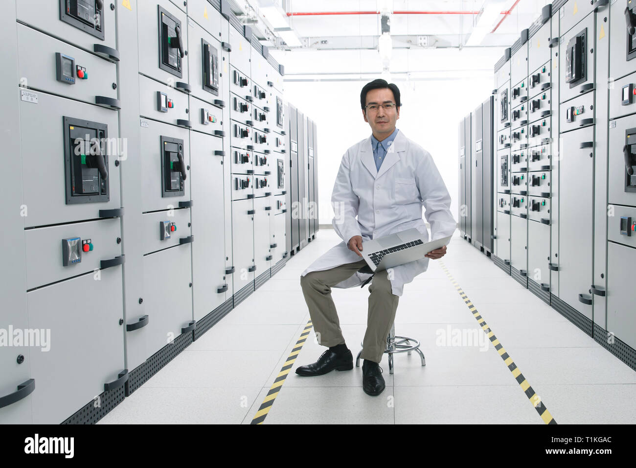 Technical personnel in the voltage room work Stock Photo - Alamy