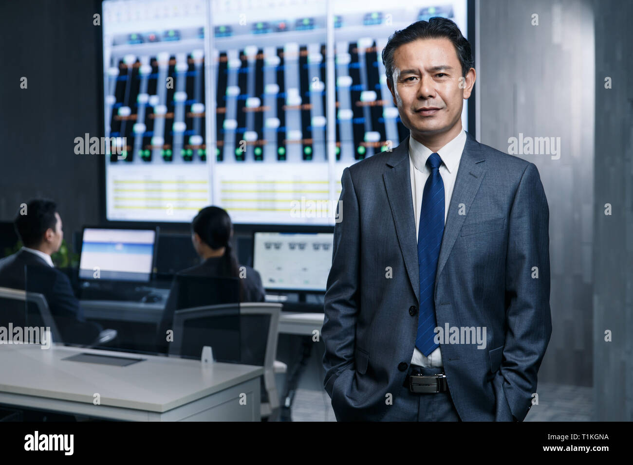 Business people in the control room Stock Photo - Alamy