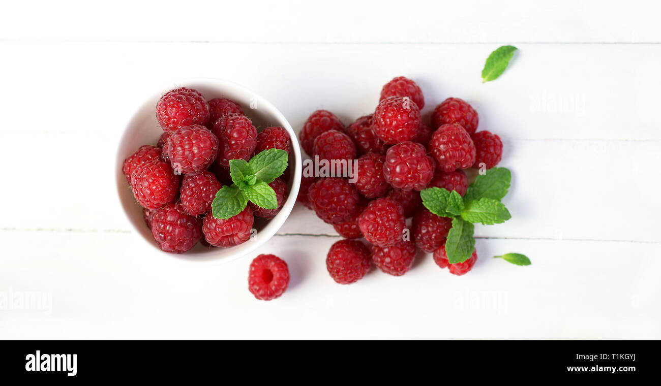 fresh raspberries with leaves of mint on white background Stock Photo ...