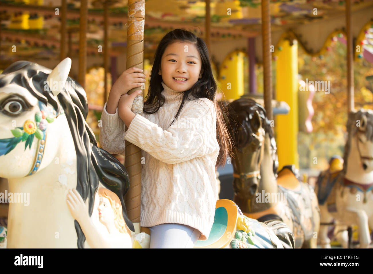 Girl sitting carousel horse hi-res stock photography and images - Alamy