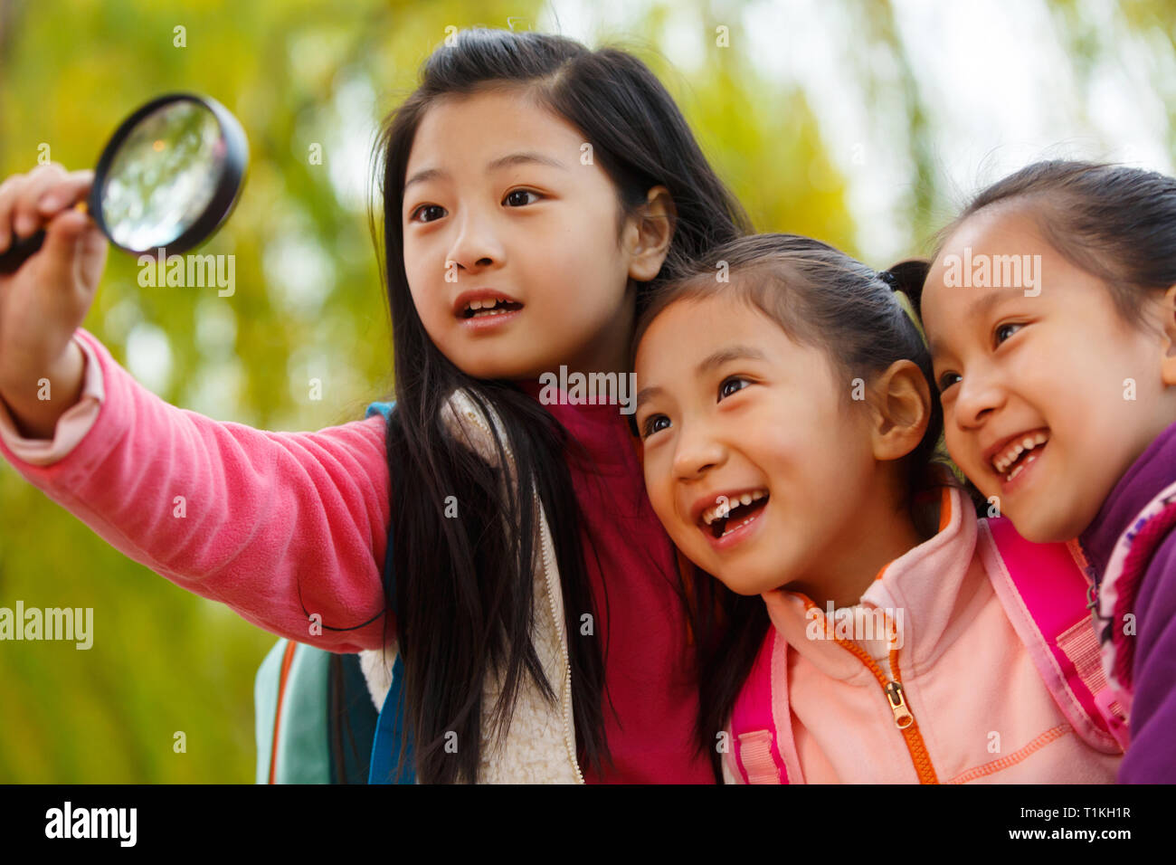 Happy little girl playing outside Stock Photo - Alamy