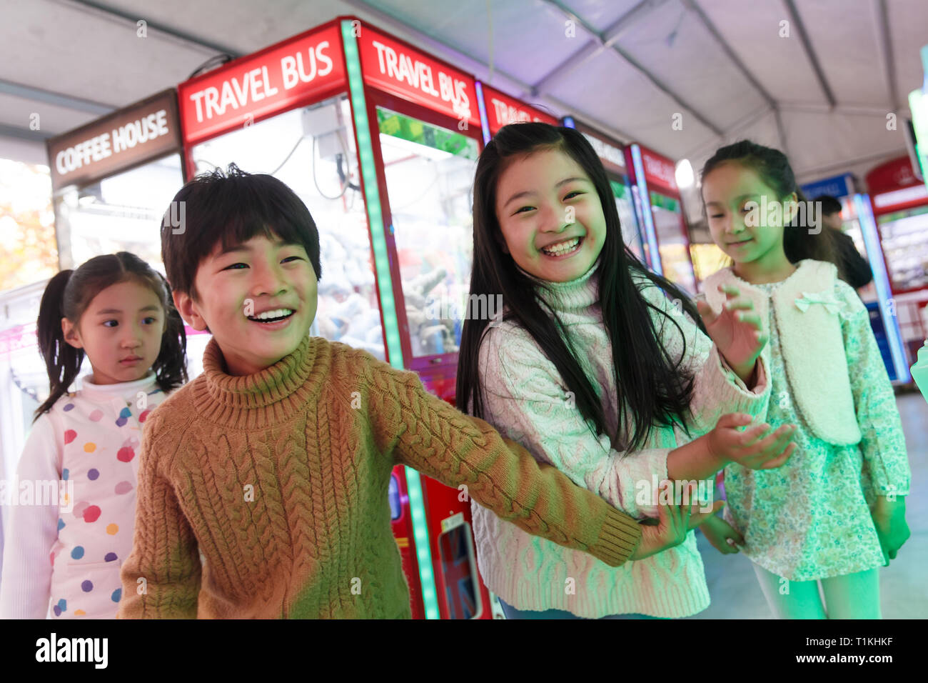 Boys and girls playing in the game hall Stock Photo - Alamy