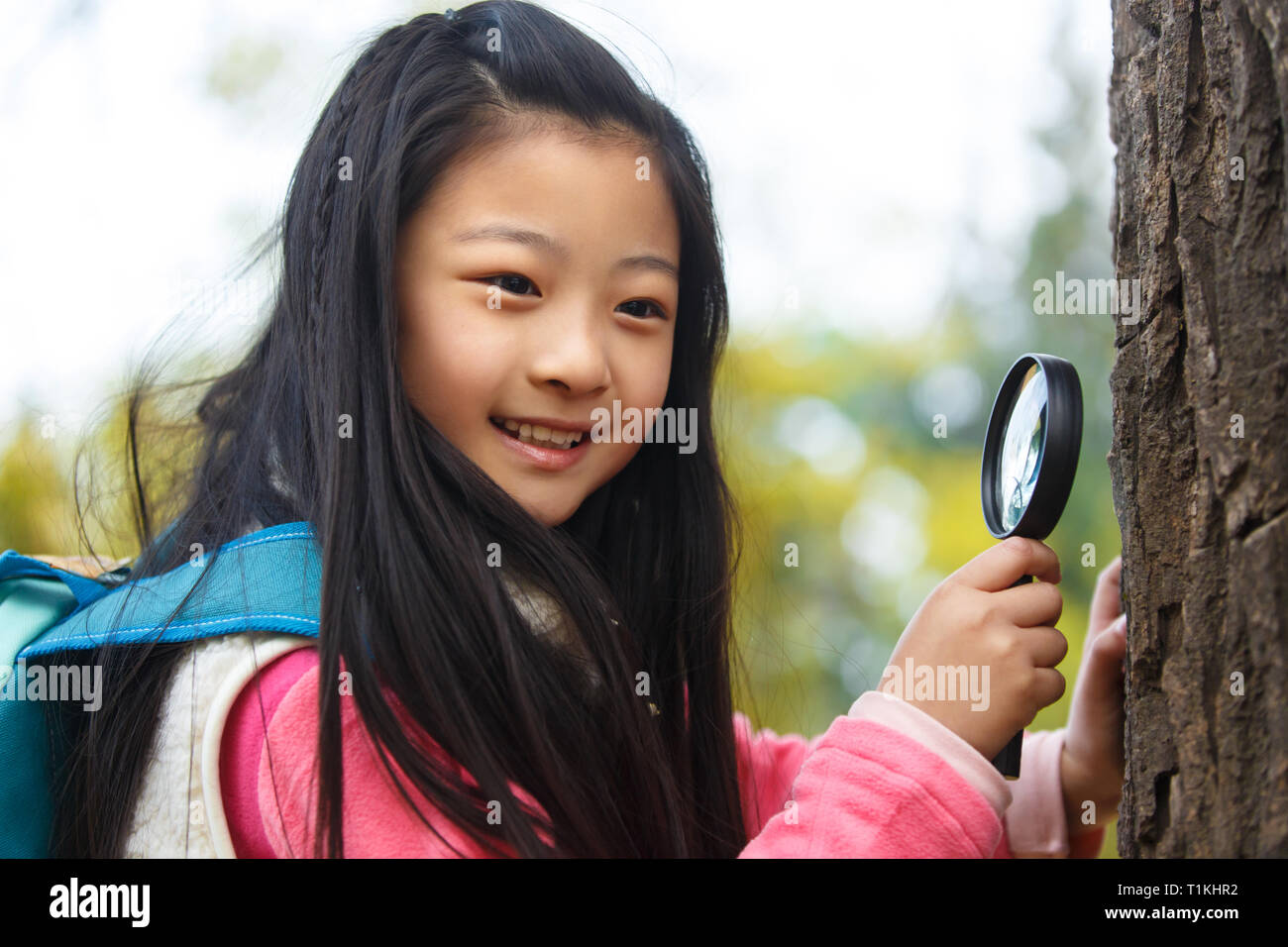 Happy little girl playing outside Stock Photo - Alamy