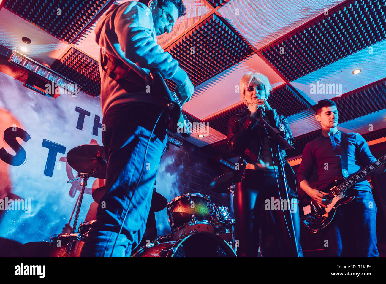 Band playing on stage making music Stock Photo - Alamy