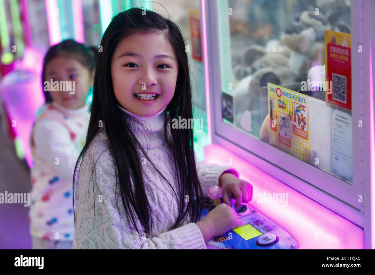 Lovely girl play in the game hall Stock Photo - Alamy