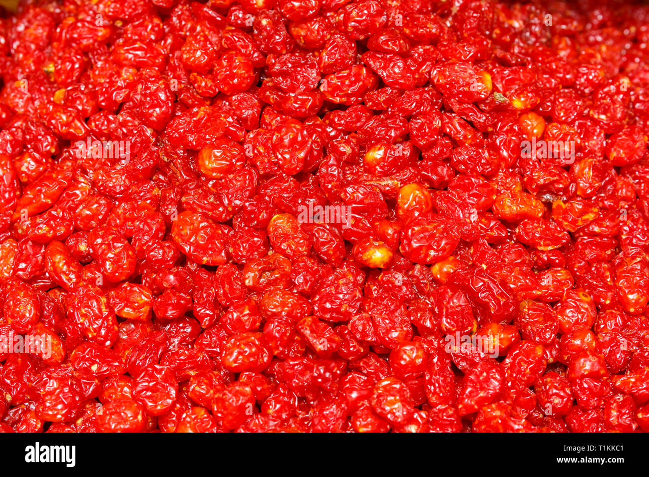 Close up of dried dates - shimmering in red color. On display for sale ...
