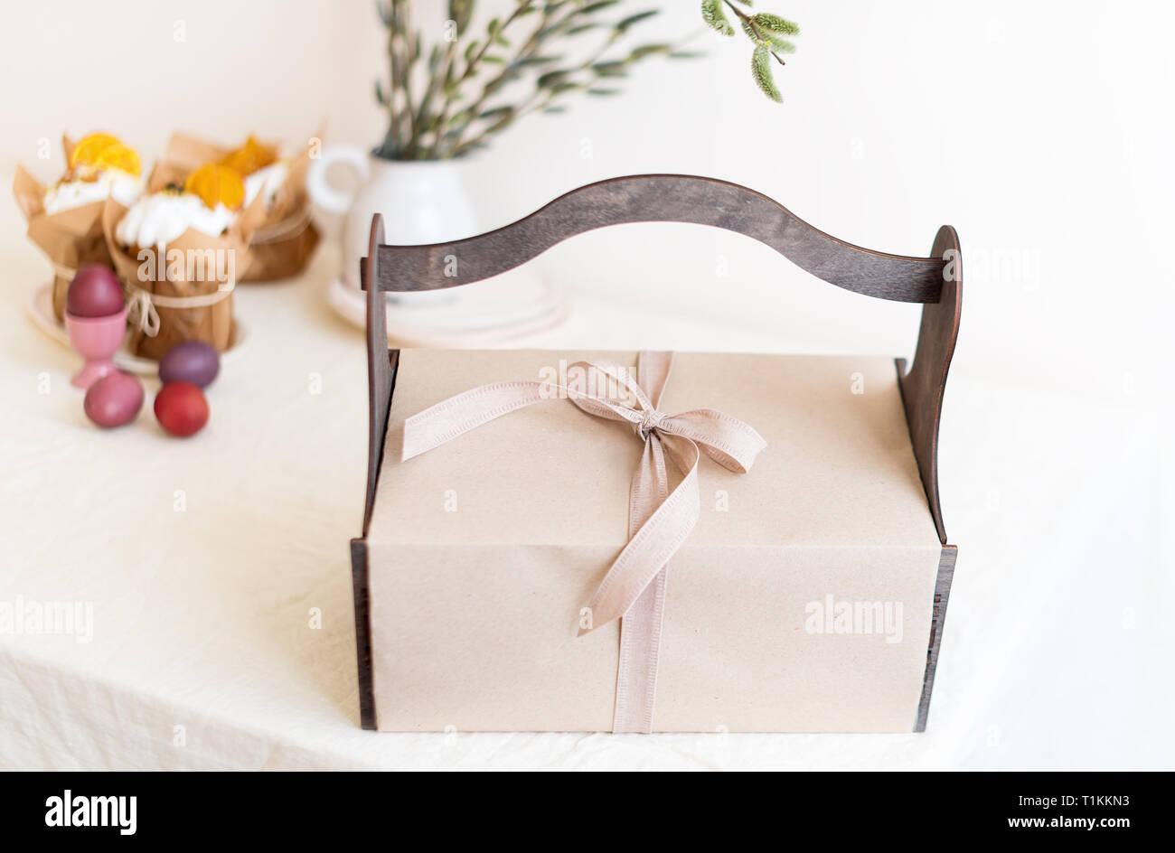 Gift box with spring flowers on light natural fabric background. Easter ...