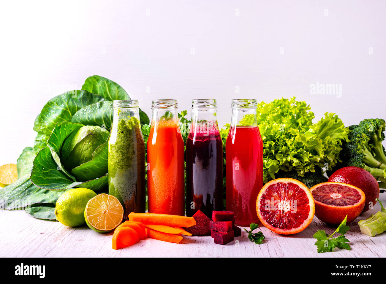 Different healthy vegan drinks with fruits and vegetables on the white ...