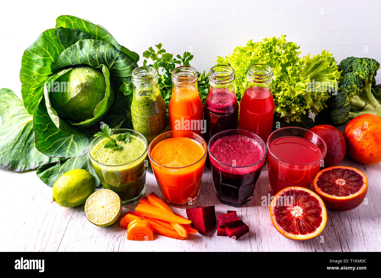 Different healthy vegan drinks with fruits and vegetables on the white ...