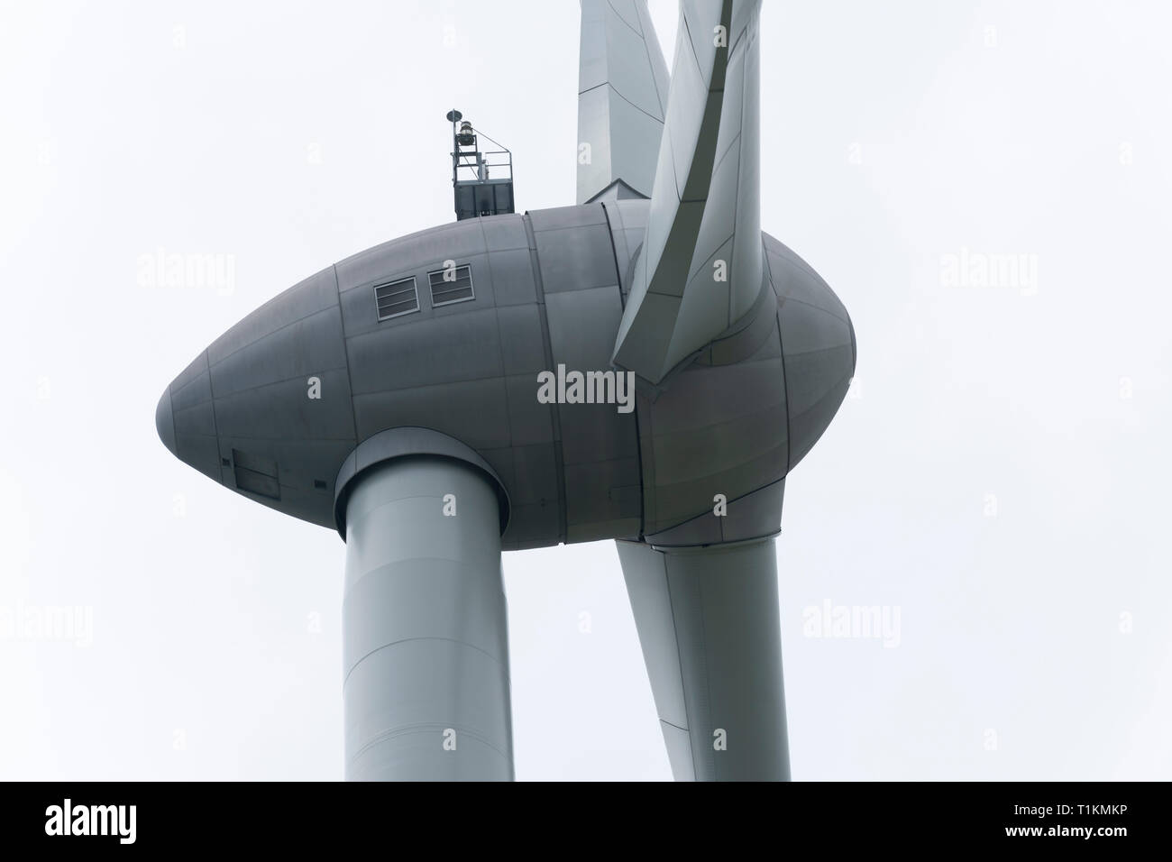 close up of the motor of a spinning windmill with a white background ...