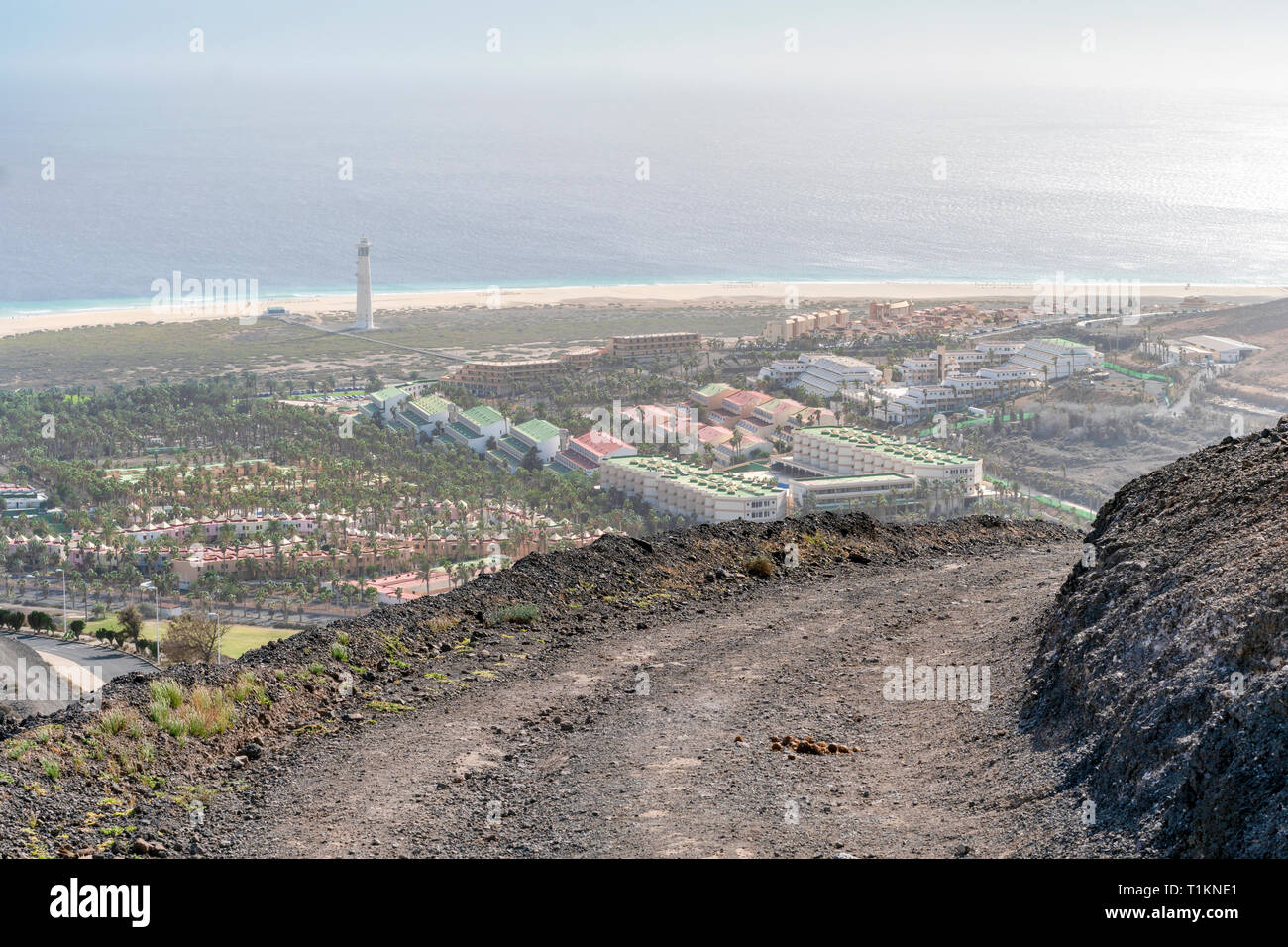 Dirt path in volcanic mountains leading from the highest peak to the ...