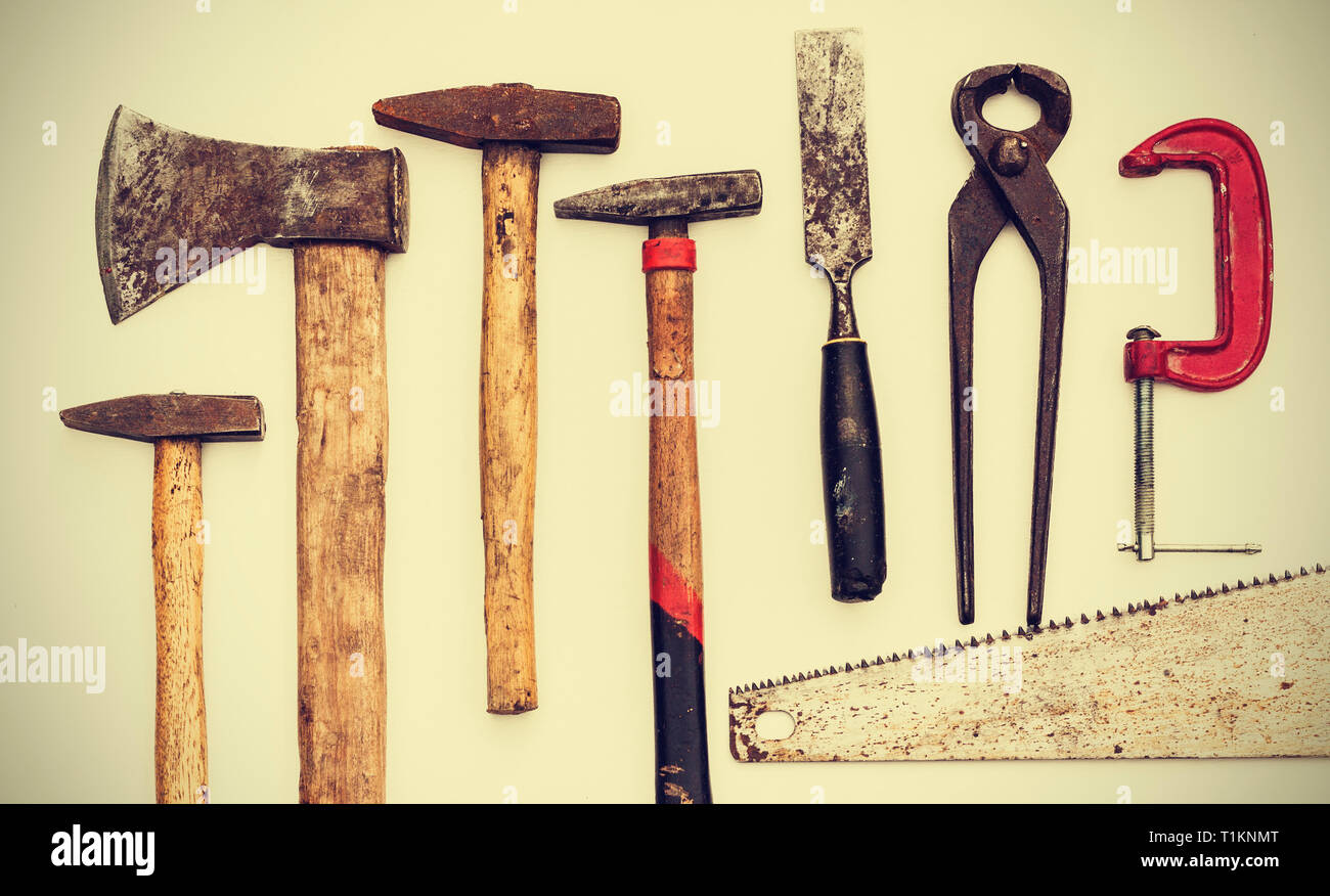 Set of vintage hand construction tools on a white wooden background ...