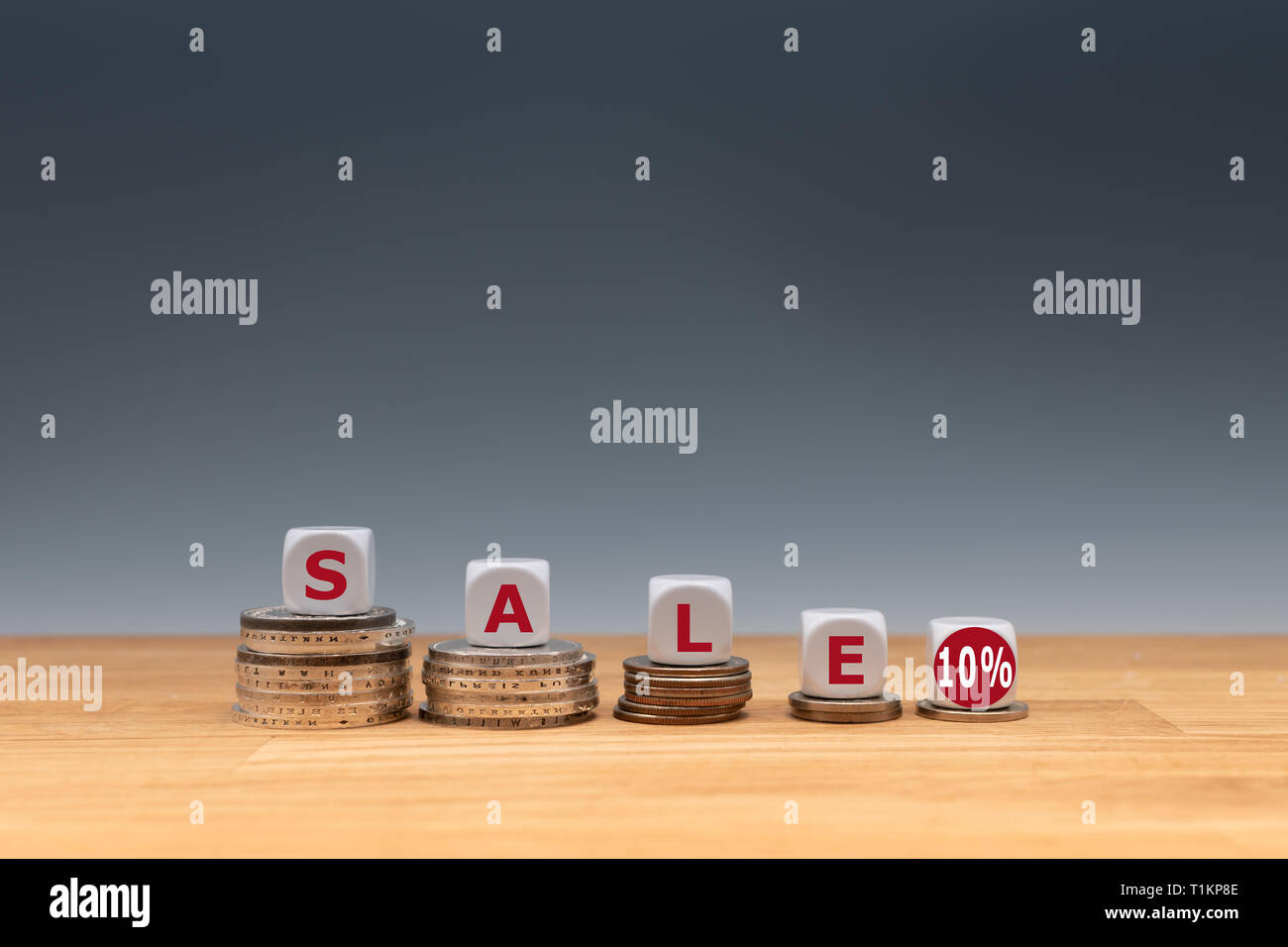 Symbol for a sale with a 10 % discount. Dice placed on coins form the ...