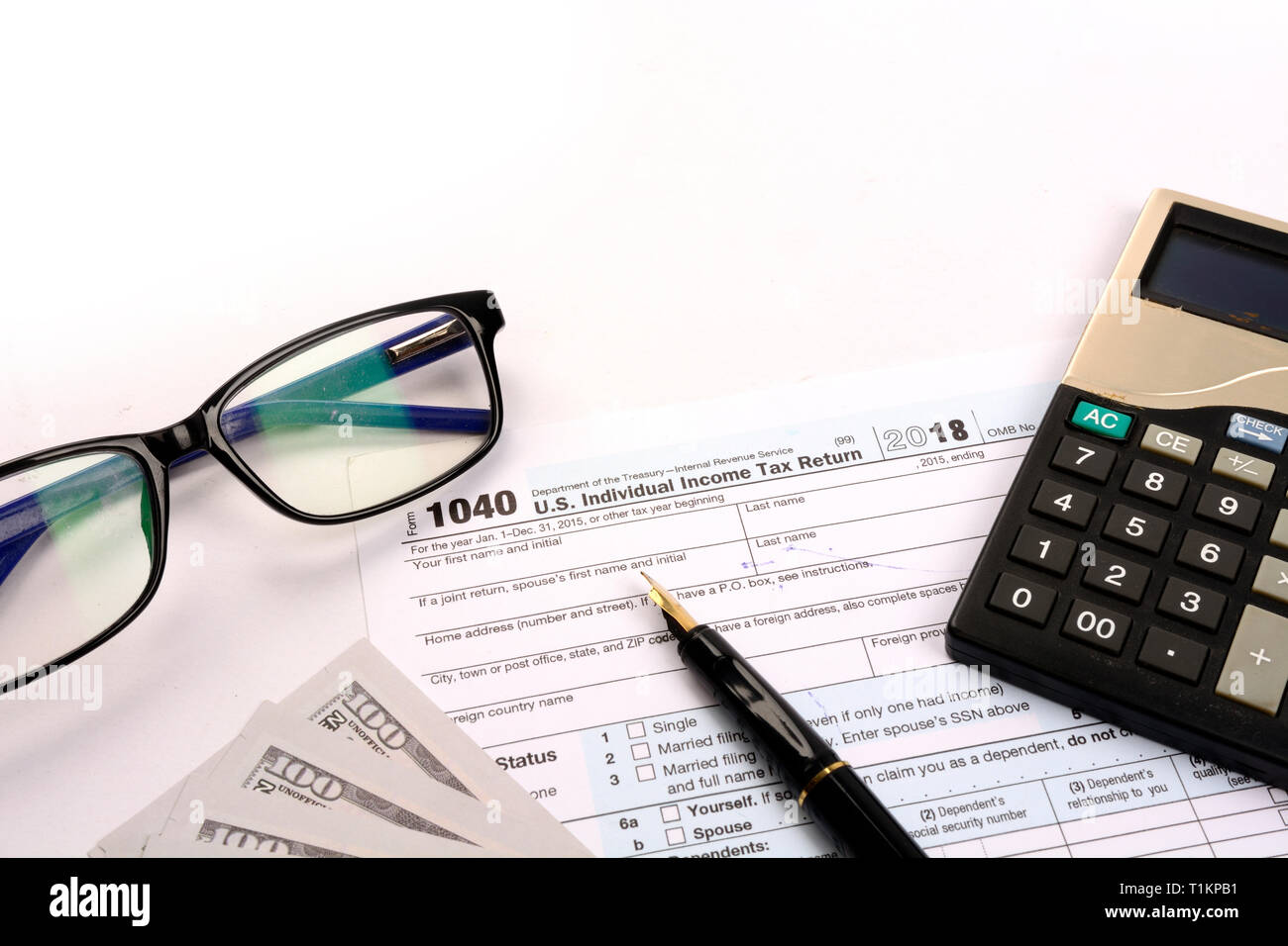 Completing US tax return form 1040 on white background Stock Photo - Alamy