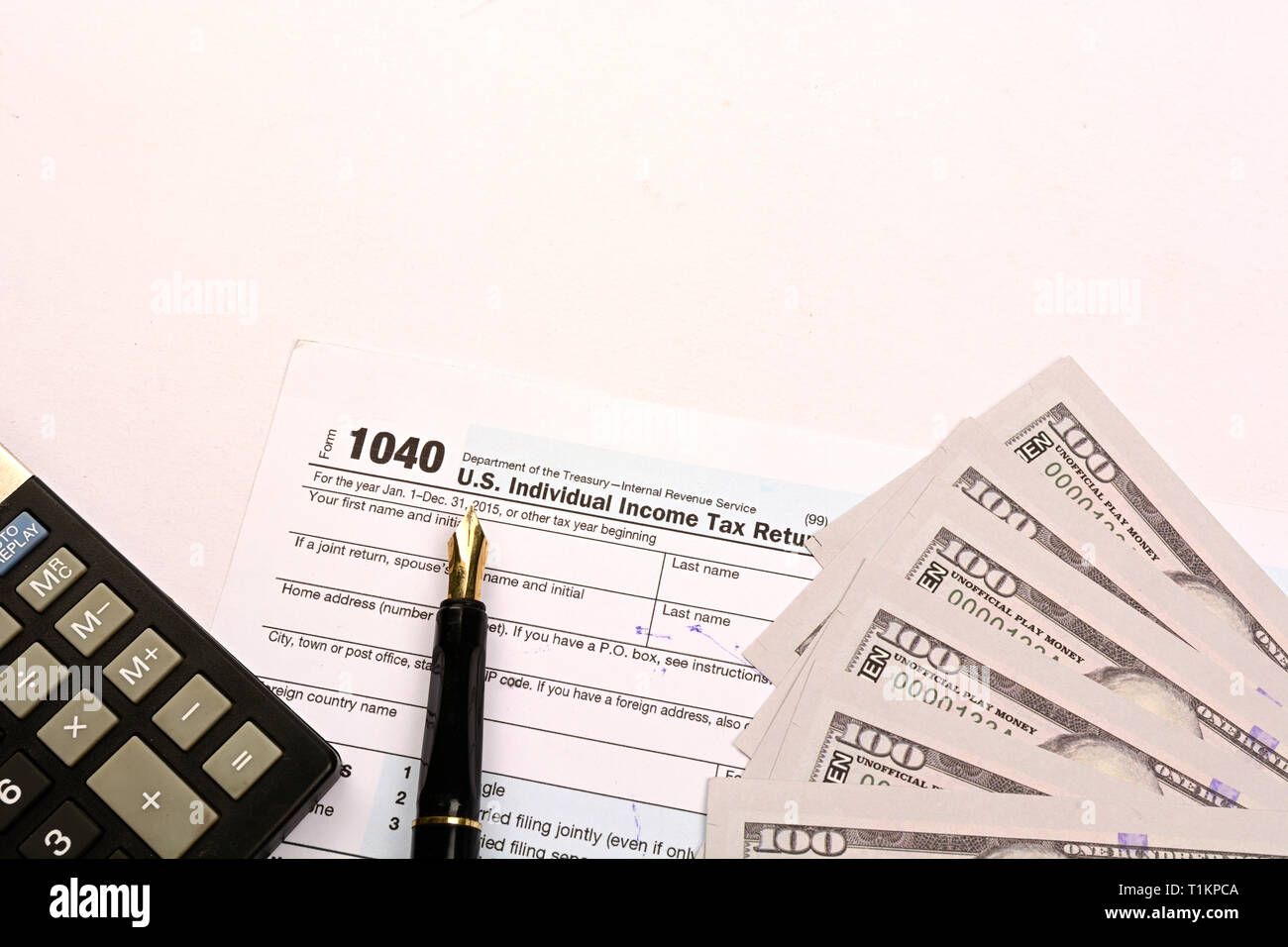 Completing US tax return form 1040 on white background Stock Photo - Alamy